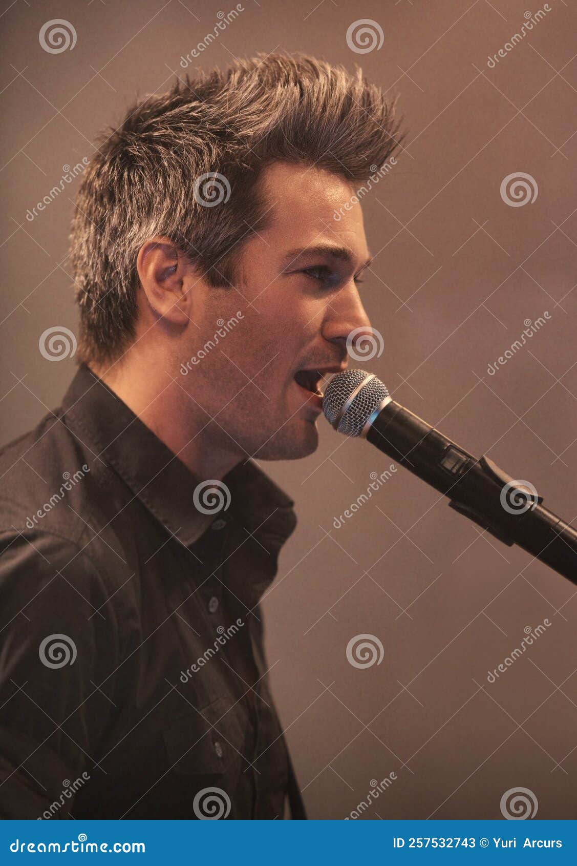 Make Your Voice Heard. a Young Performer Singing into a Microphone ...