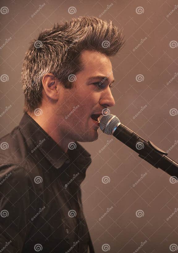 Make Your Voice Heard. a Young Performer Singing into a Microphone ...