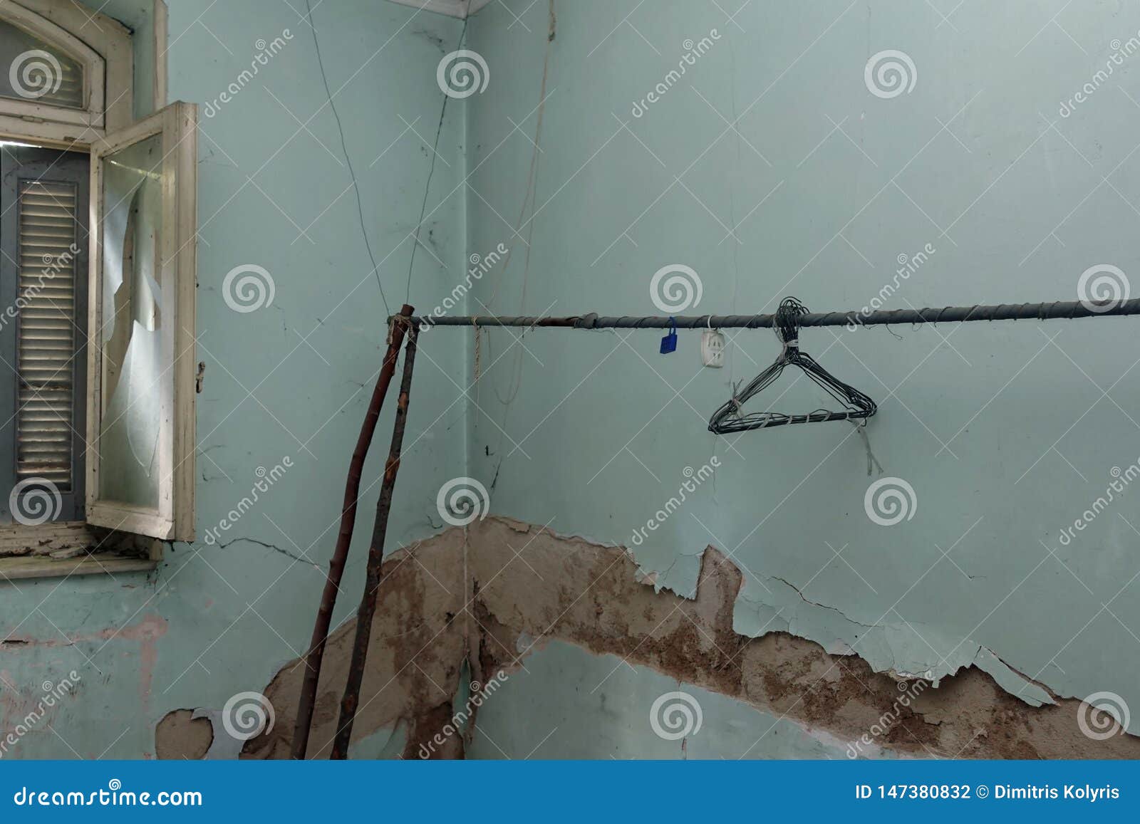 Makeshift Clothesline with Rusty Hangers in Decayed Blue Room Stock ...
