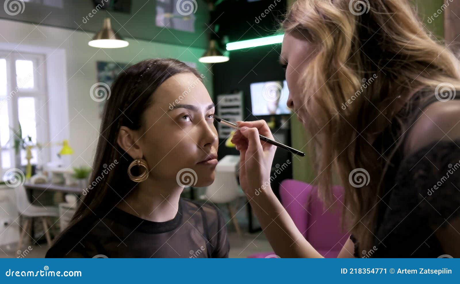 Makeup Artist Applies Base Tone Cream On Girl S Face Using Brush In