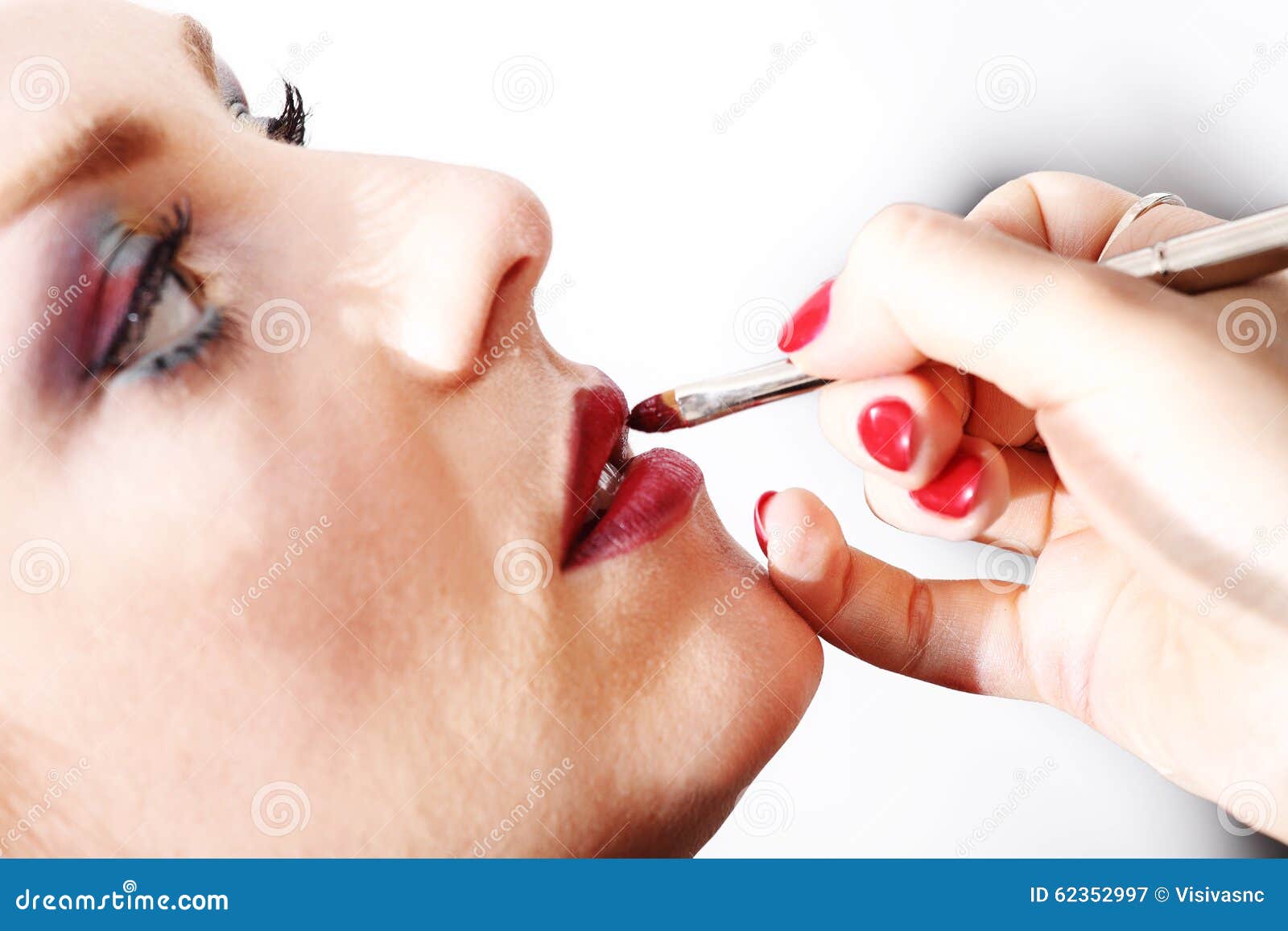 Makeup Artist Applying Lipstick on Model Lips with Brush Stock Image ...