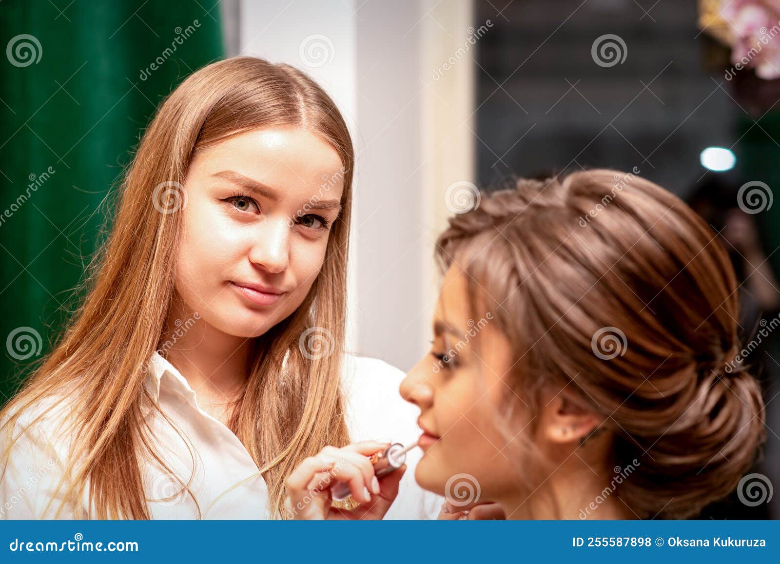 Makeup In The Process The Makeup Artist Applies Pink Gloss Lipstick On