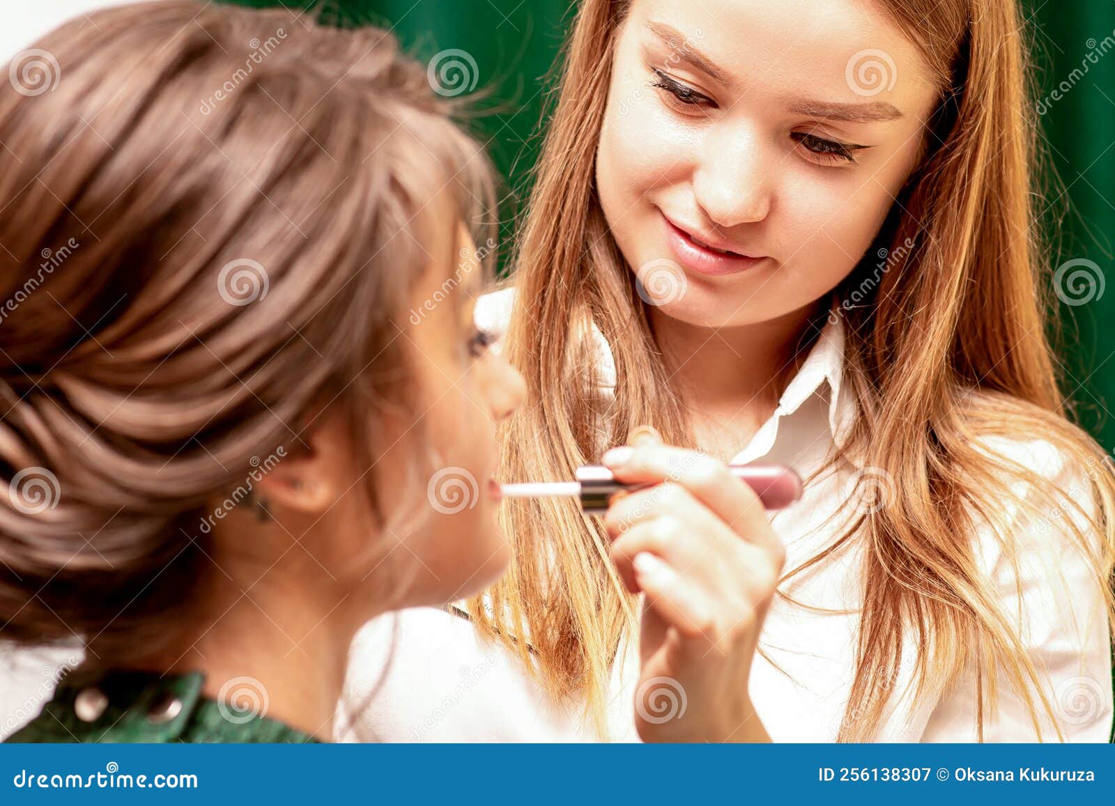 Makeup In The Process The Makeup Artist Applies Pink Gloss Lipstick On