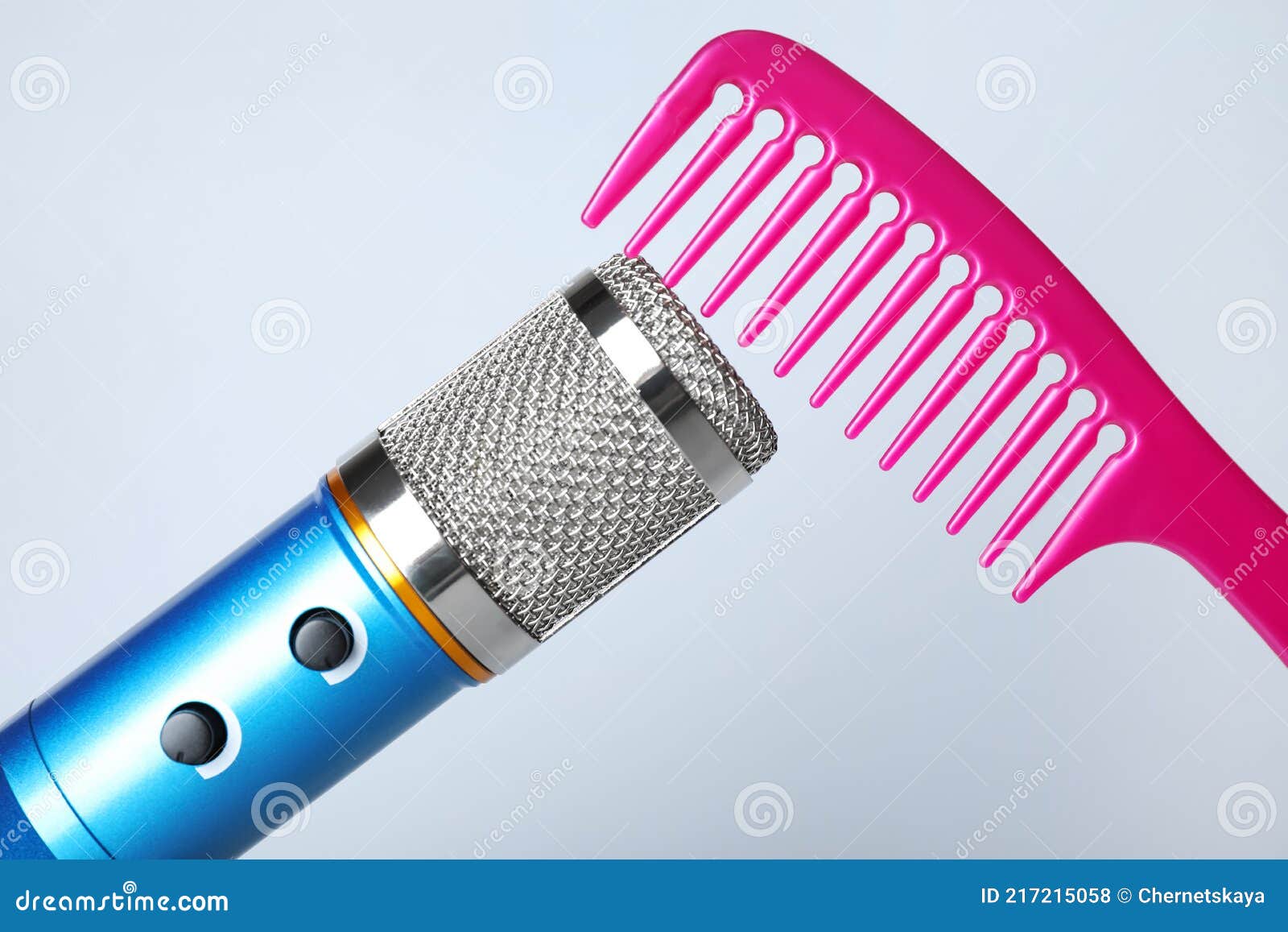 Making ASMR Sounds with Microphone and Comb on Grey Background, Closeup ...