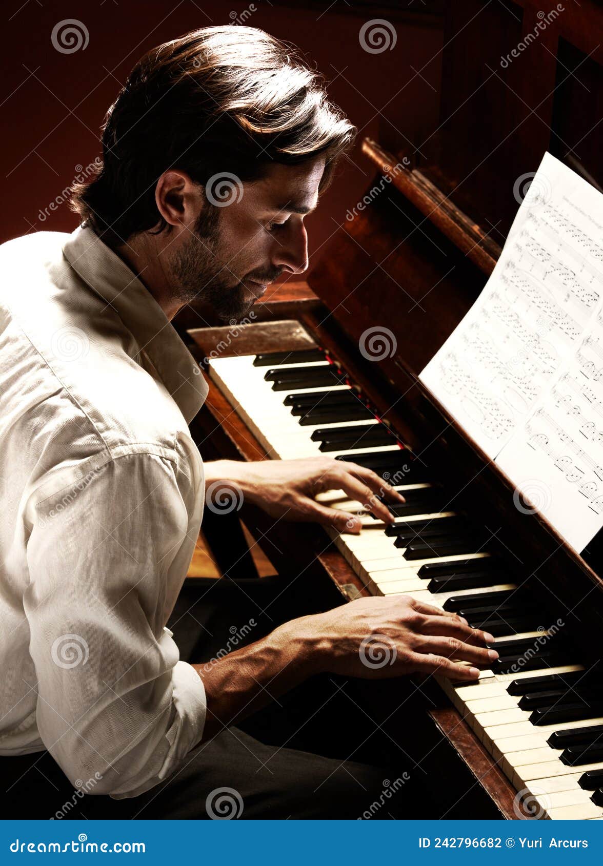 Making Beautiful Music. Profile of a Handsome Man Playing the Piano ...