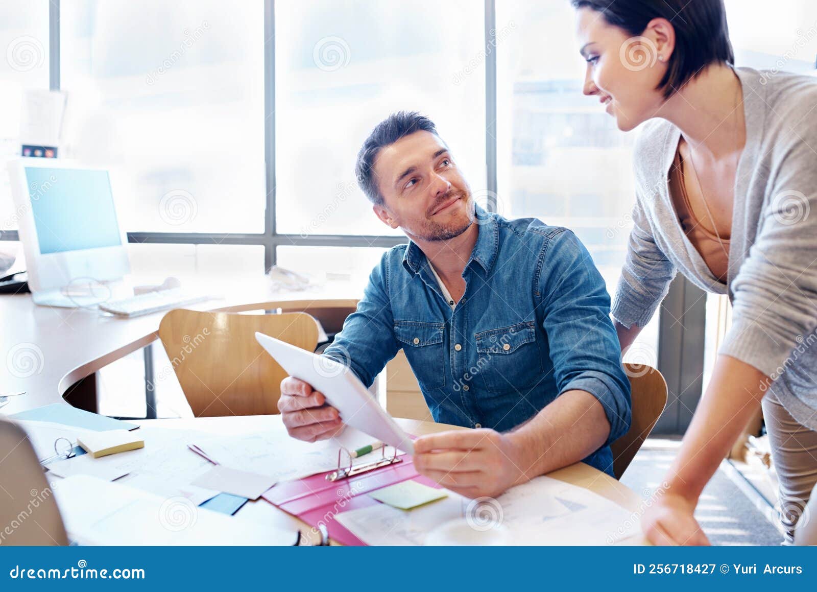 Making Connections. Two Coworkers Using a Tablet in a Discussion. Stock ...