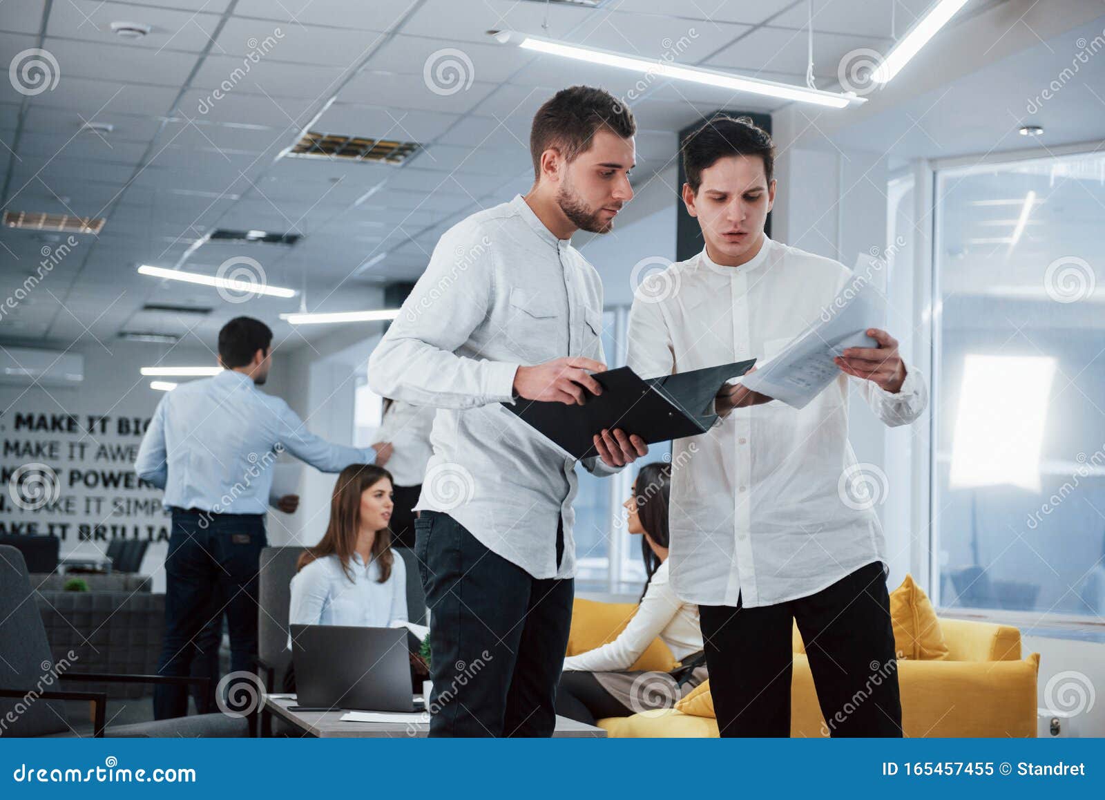Making Corrections in Report. Two Office Workers in Classic Clothes ...