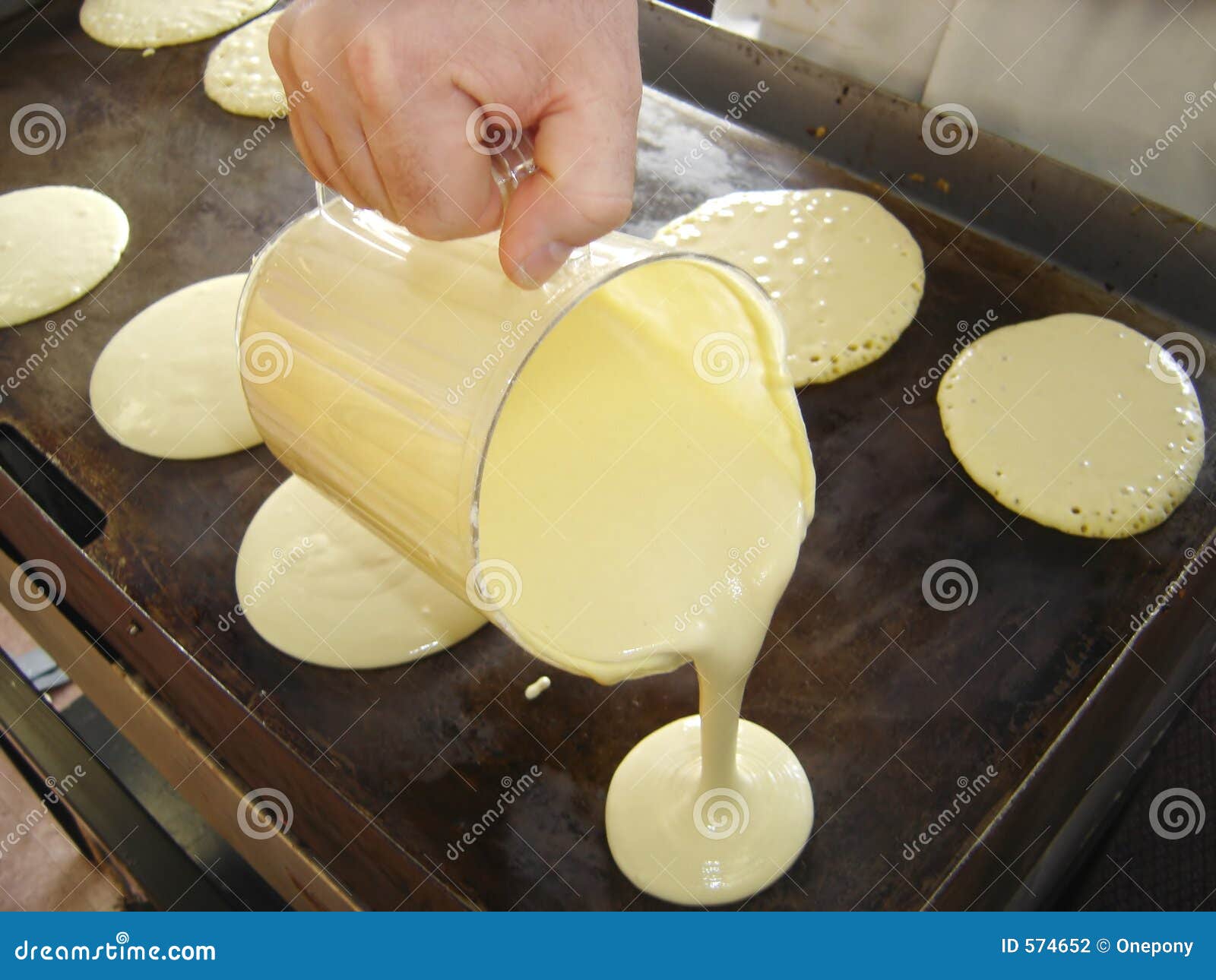 Making Griddle Cakes stock photo. Image of griddle, cooking - 574652