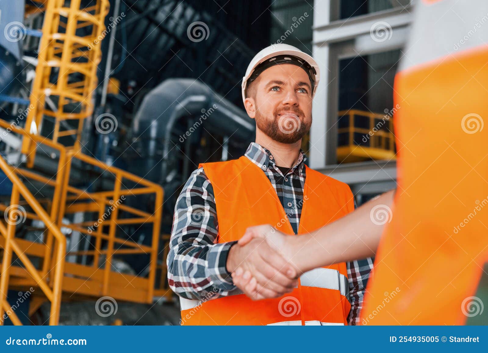 Making Handshake with Customer. Construction Worker in Uniform is in the Factory Stock Image ...