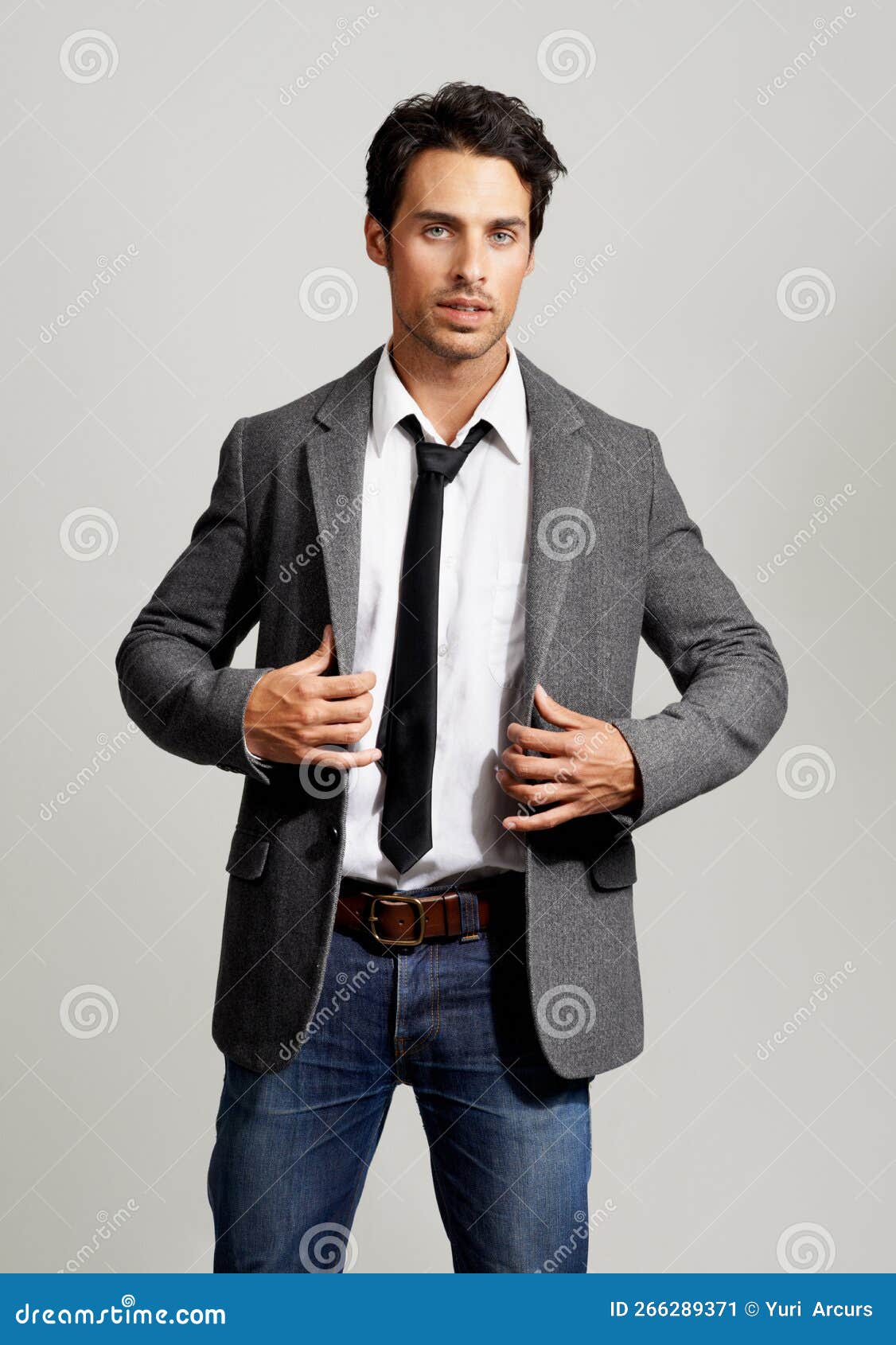 Making Himself Presentable. Portrait of a Handsome Young Man Pulling ...