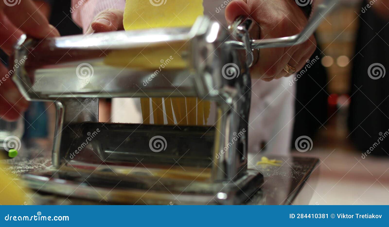 Making Homemade Pasta. Using a Pasta Machine, the Chef Prepares Pasta ...