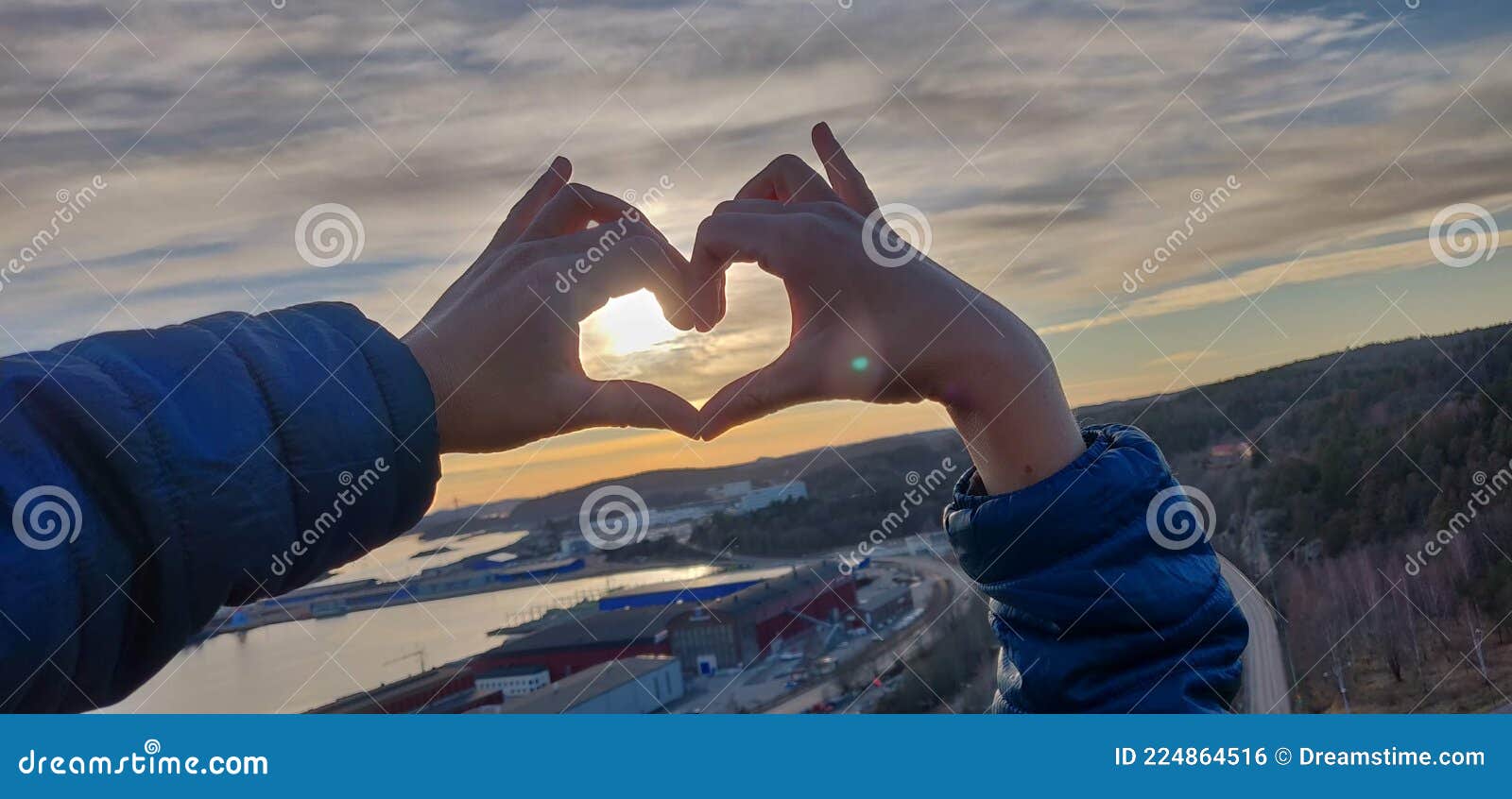 Making Imperfect Heart Shape with Hands at Cloudy Sunset Stock Photo ...