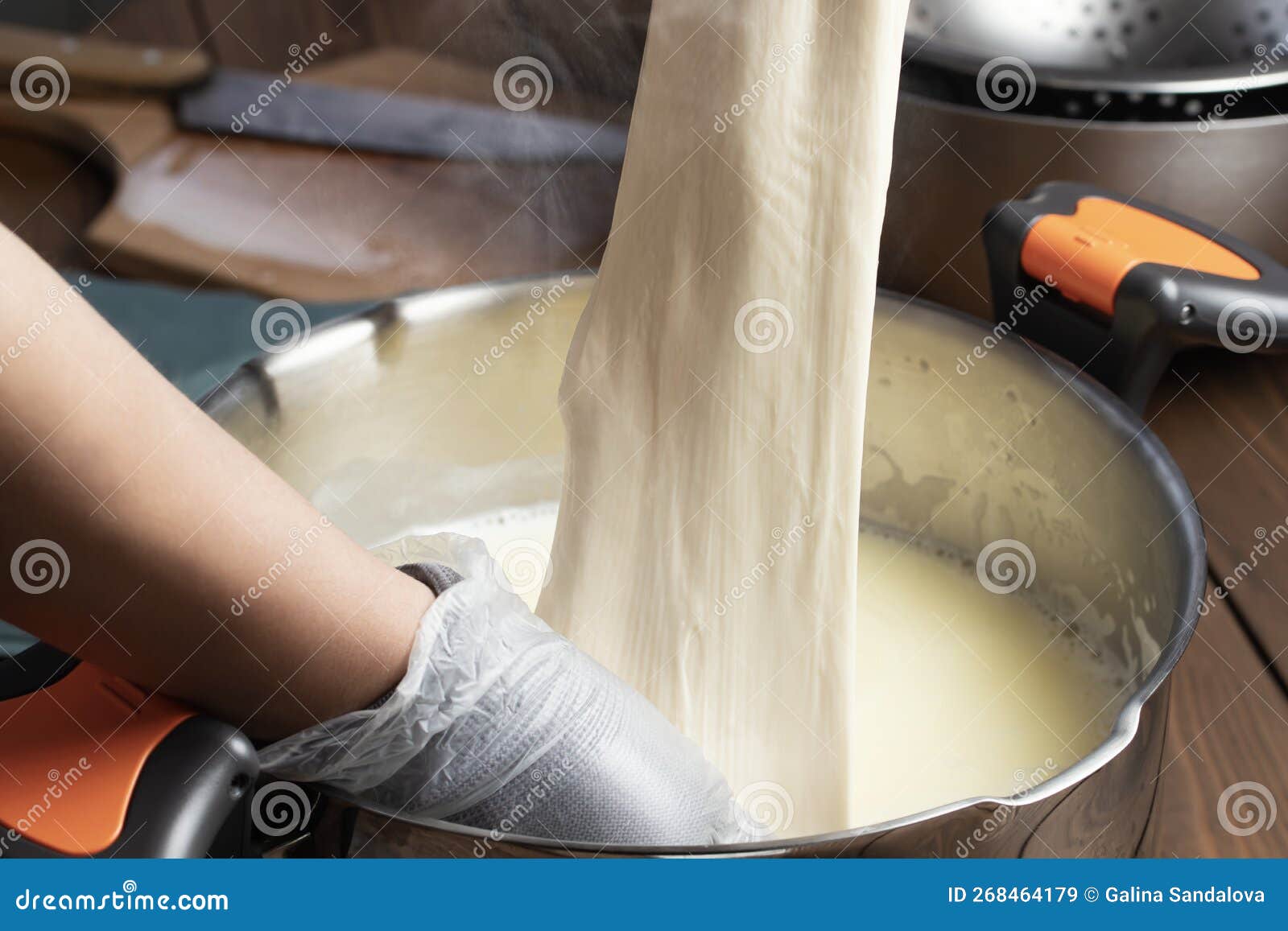 Making Mozzarella Cheese. Pulling Out the Cheese Clot after Heating in ...