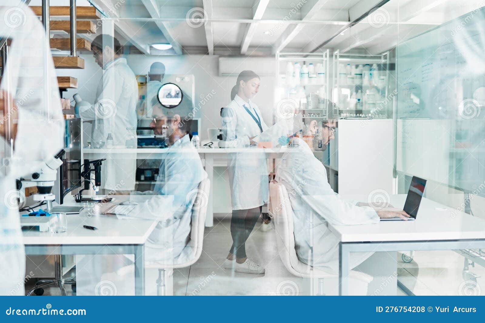 Making New Discoveries Around the Clock. Scientists Working in a Lab ...