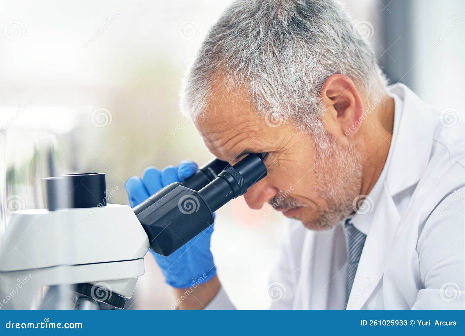 Making New Discoveries. a Scientific Researcher at Work on a Microscope ...