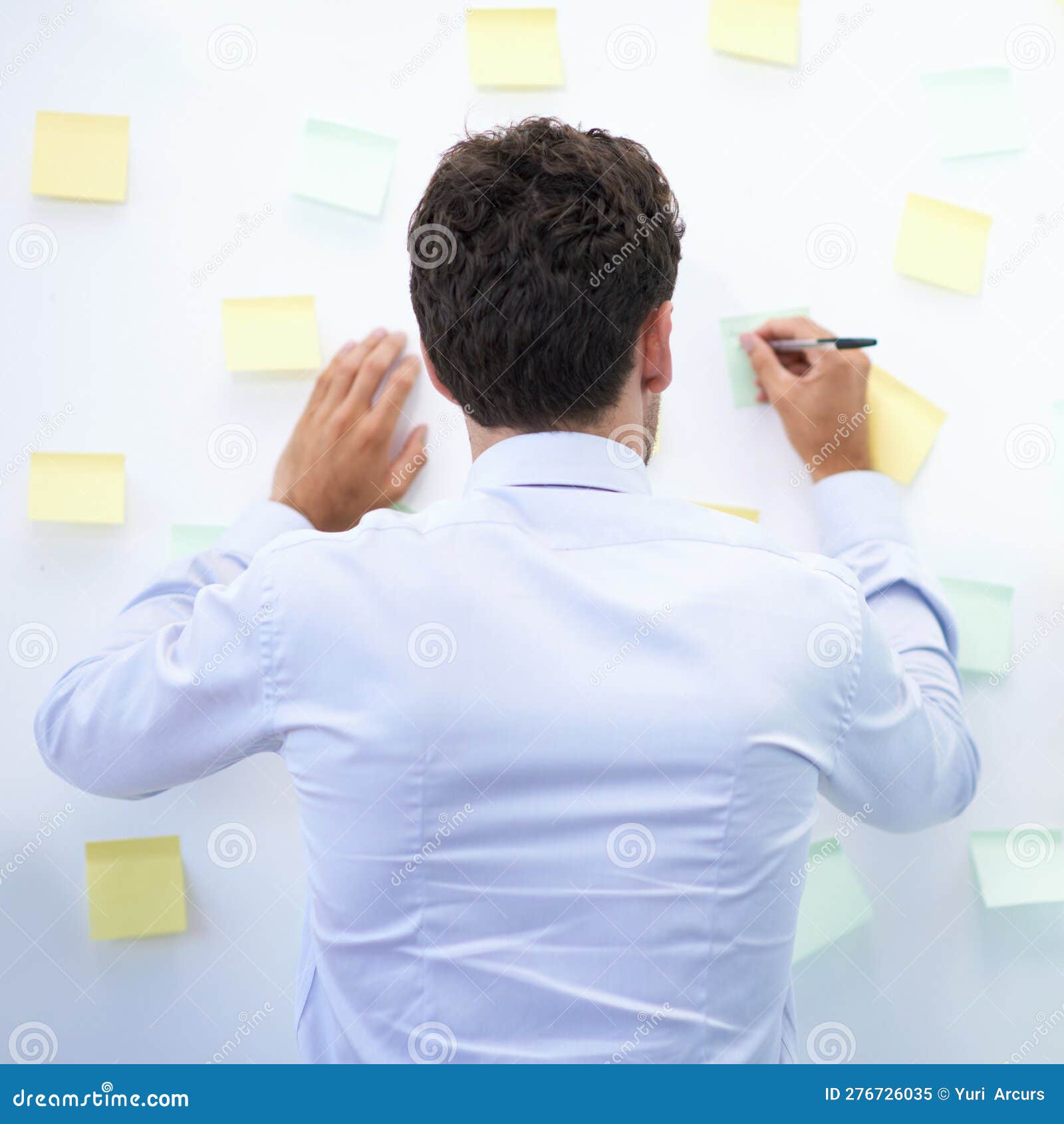 Making a Note for Every Assignment. Rearview Shot of a Businessman ...