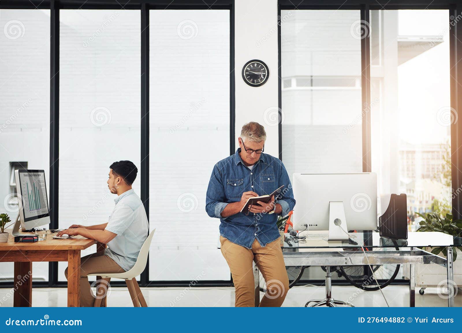 Making a Note in His Diary. Two Male Designers Working Individually in ...