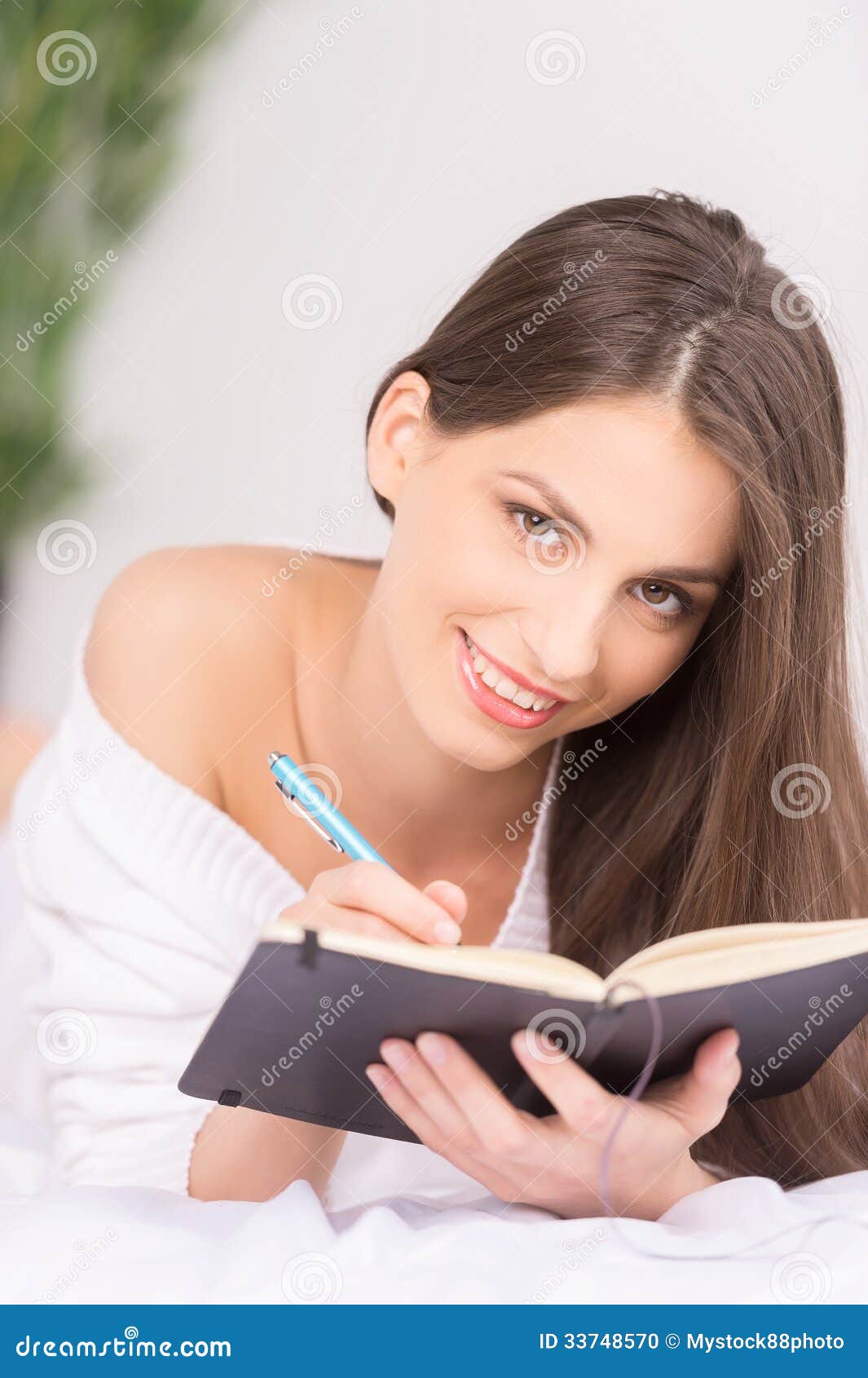 Making notes. stock photo. Image of hair, home, holding - 33748570
