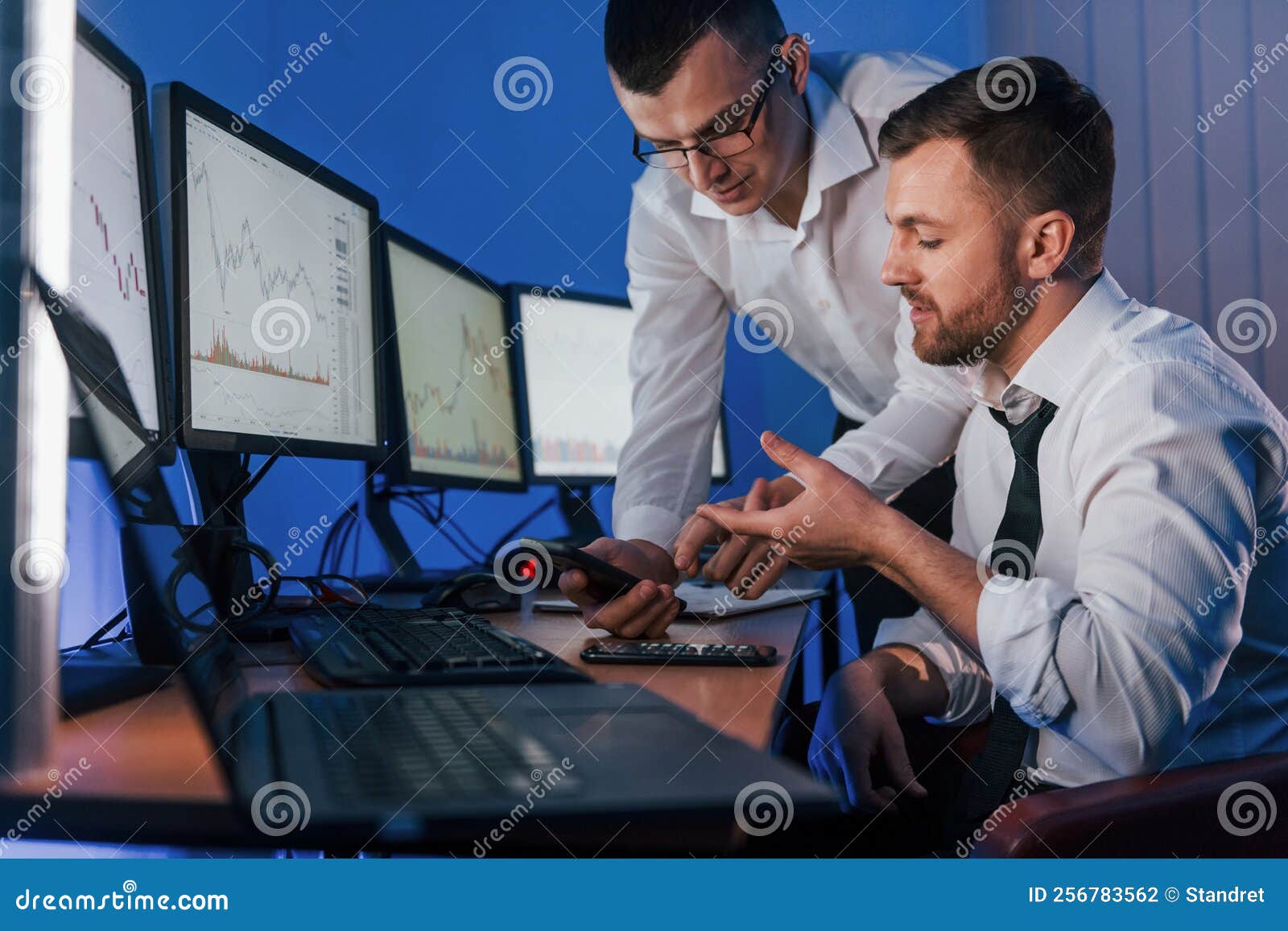 Making Profit. Two Stock Traders Working in the Office with Exchange ...