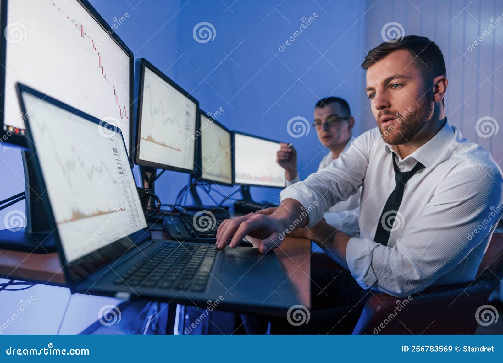 Making Profit. Two Stock Traders Working in the Office with Exchange ...