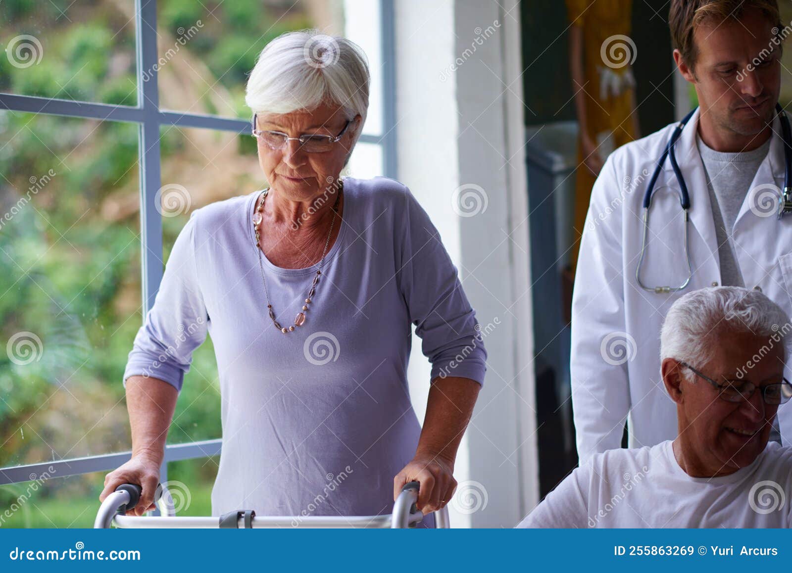 Making Progress. Two Senior People Being Helped by Nursing Staff. Stock ...