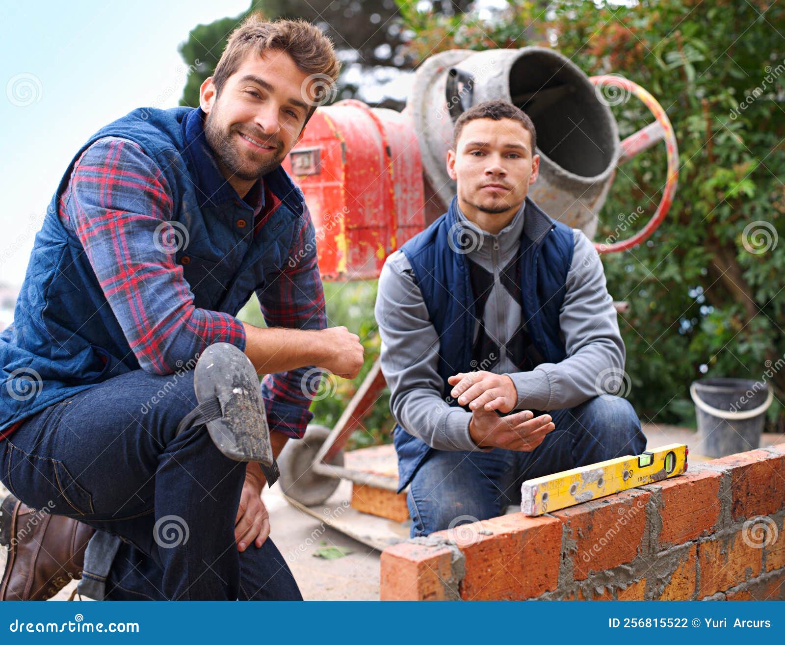 Making Strong Foundations. Portrait of a Bricklayer and His Apprentice ...