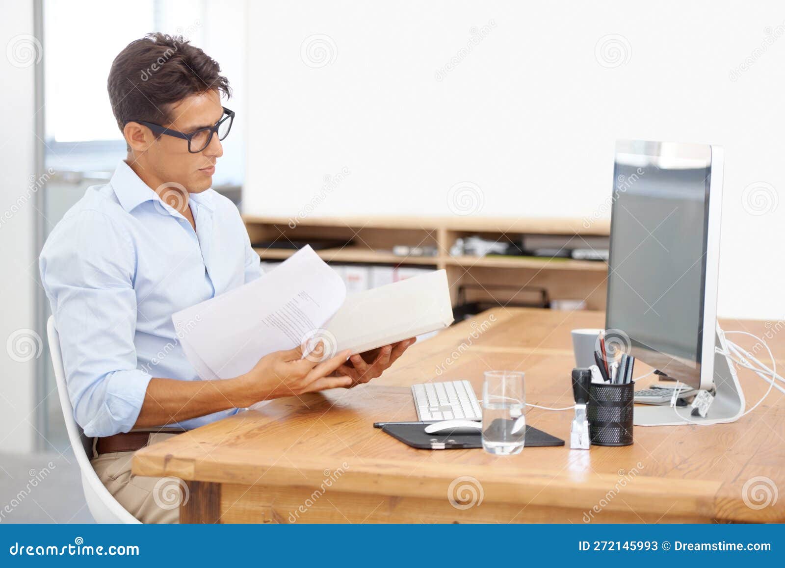 Making Sure Everything is in Order. a Young Businessman Wearing Glasses ...