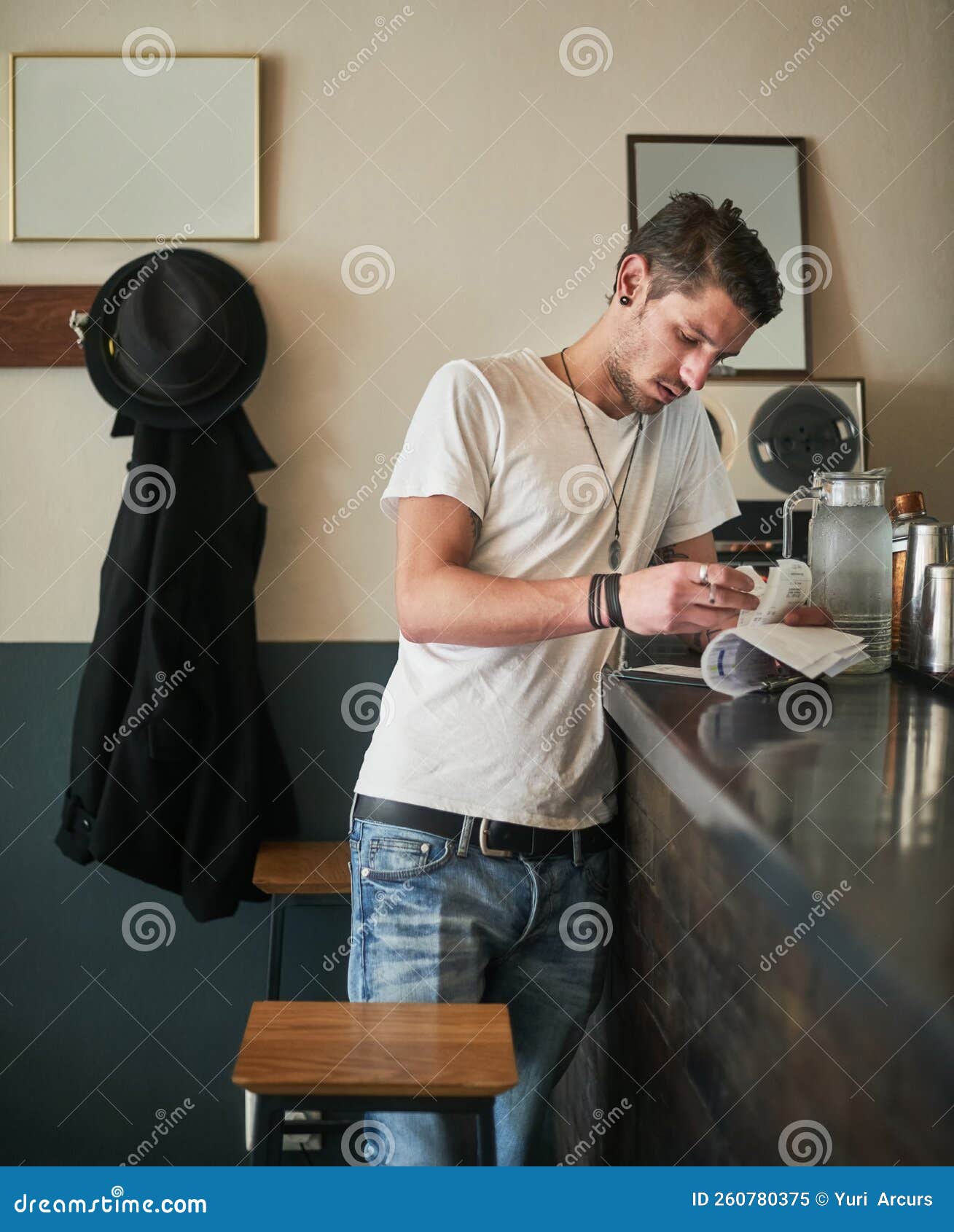 Making Sure the Numbers Add Up. a Focussed Young Bartender Making Notes ...