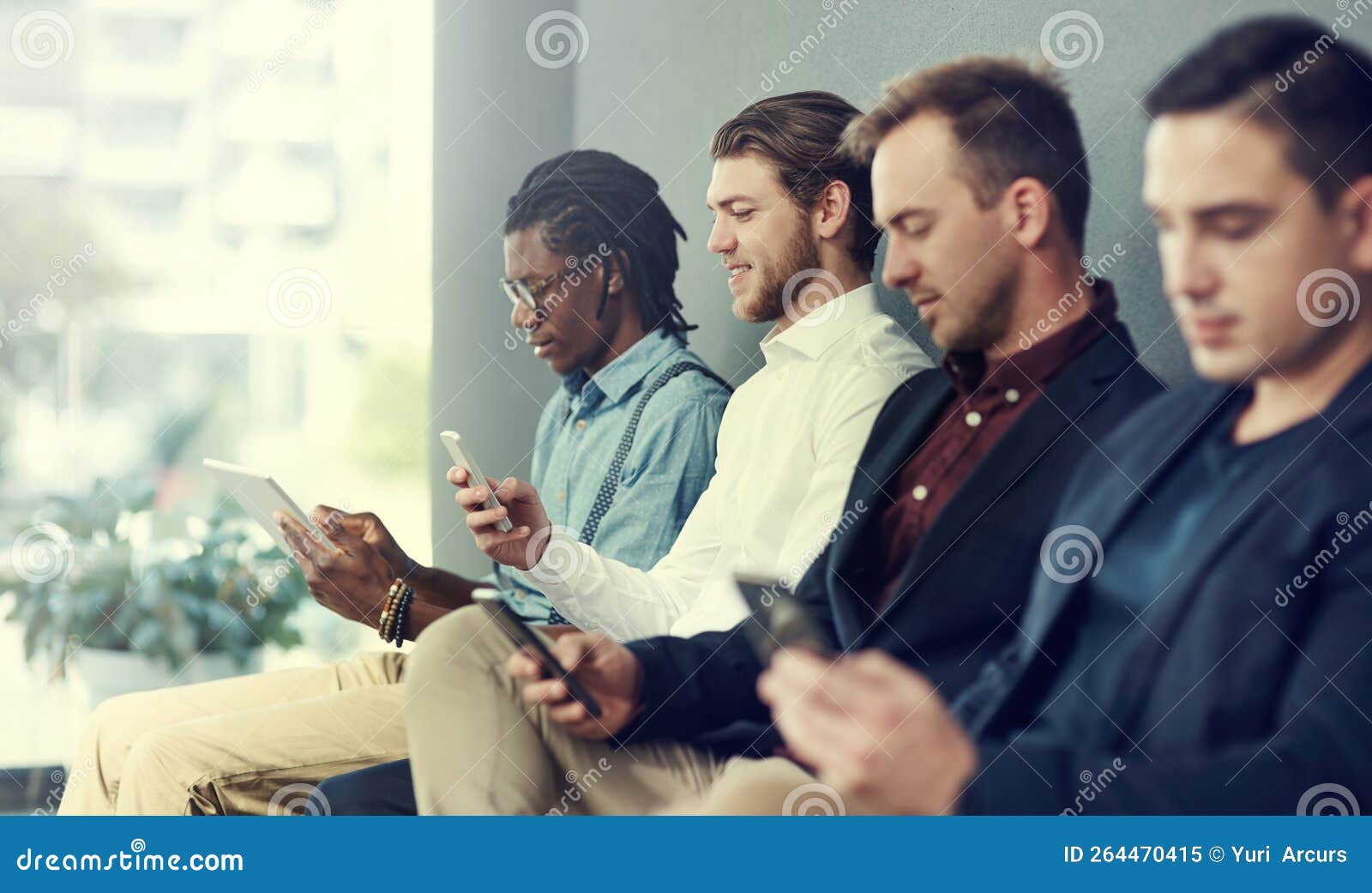 Making Use of Their Waiting Time. a Group of Businessmen Using ...
