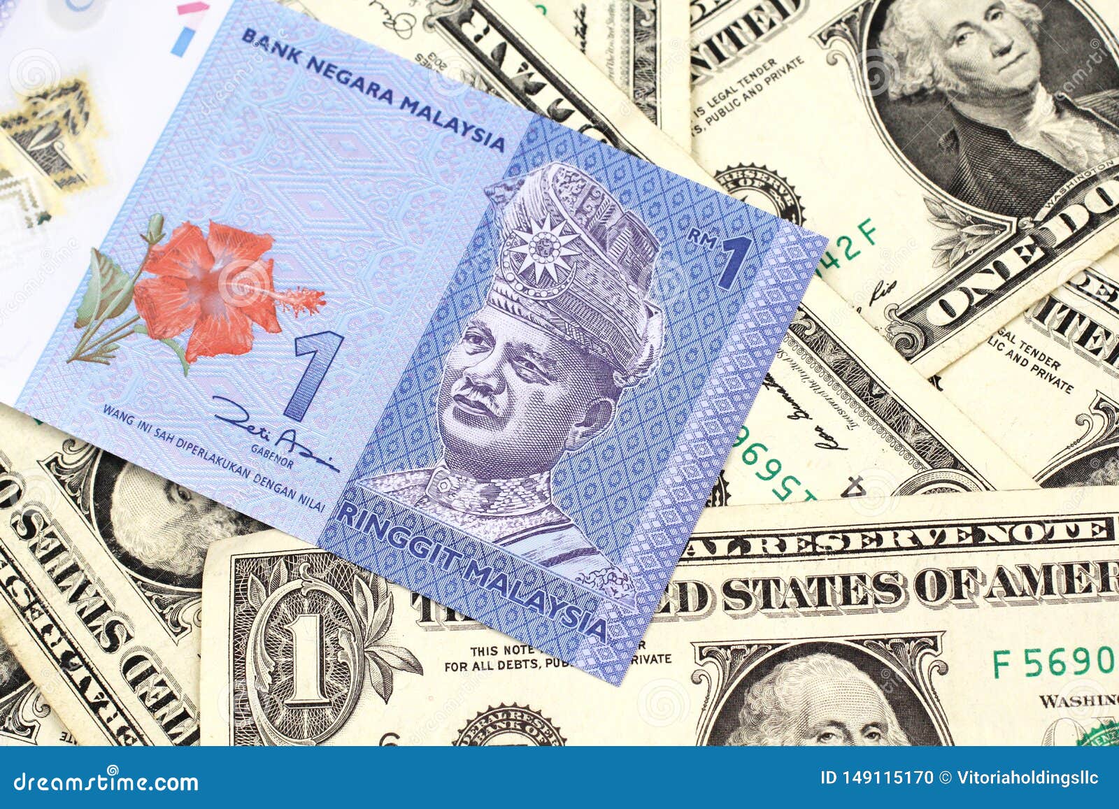 A Malaysian Ringgit on a Background of One Dollar Bills Stock Photo ...
