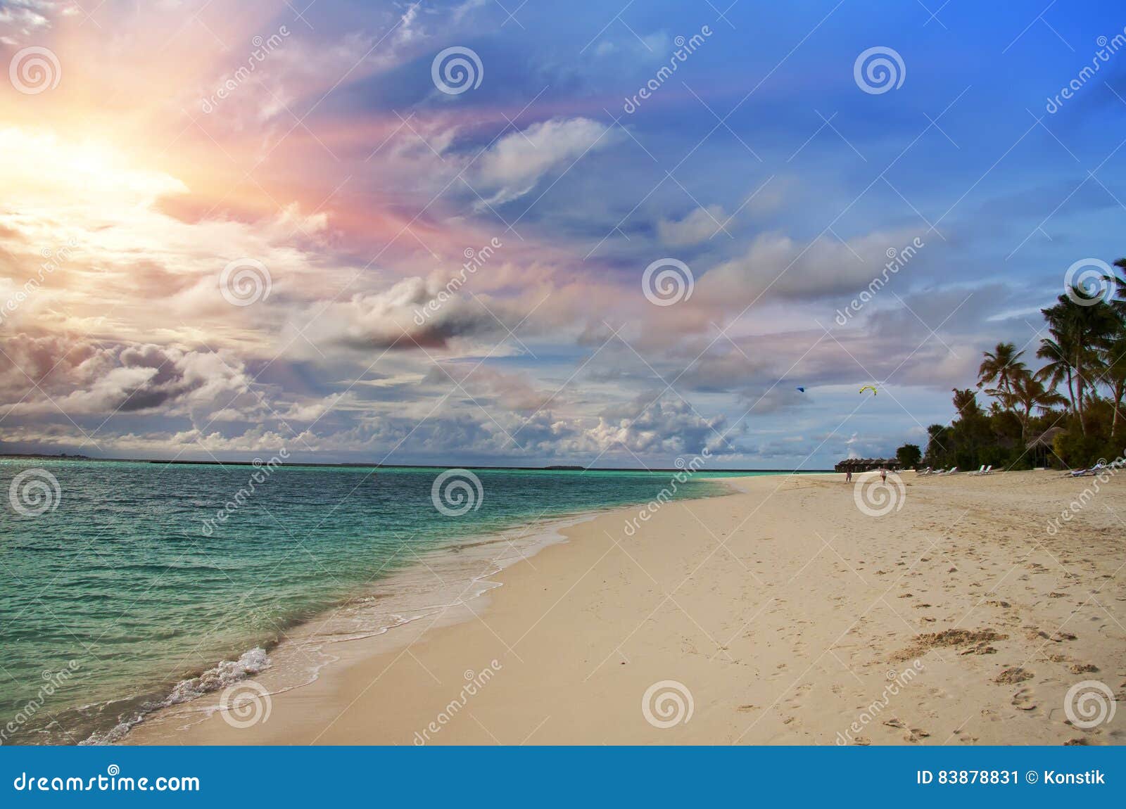 Maldives. Sunshine through Clouds Light the Beach with Palm Trees Stock ...