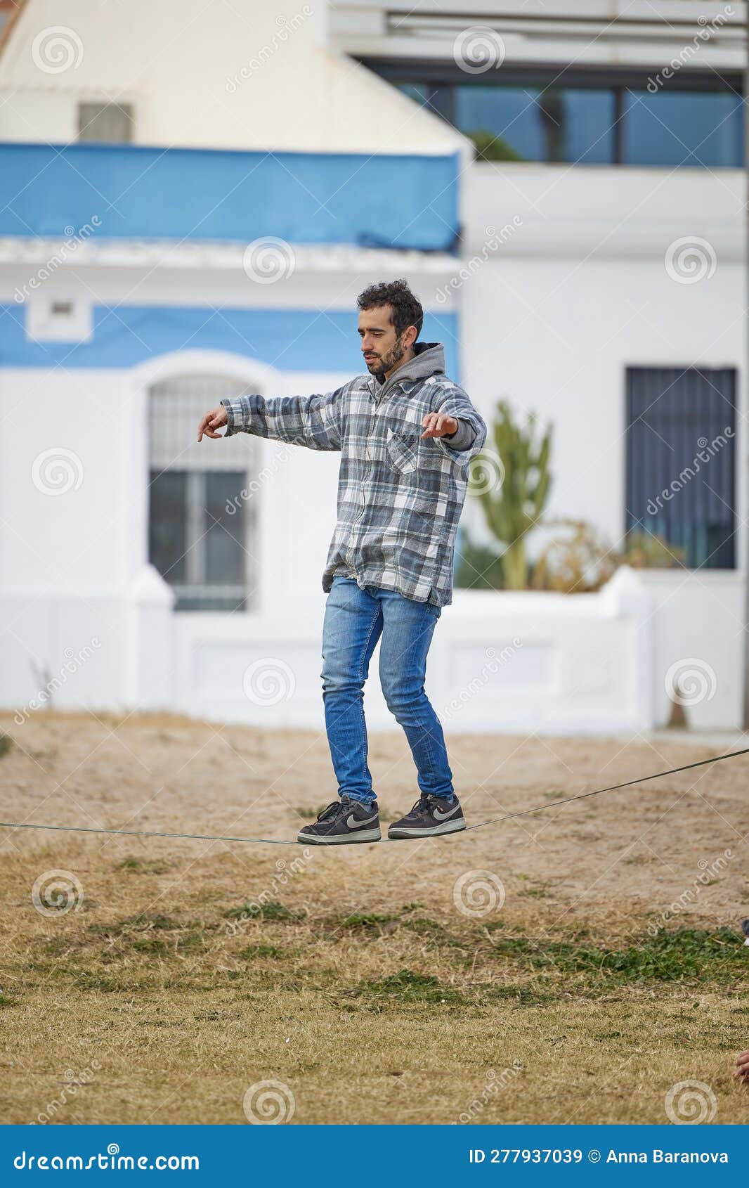Male Acrobat Balances Standing on a Rope Editorial Stock Image - Image ...
