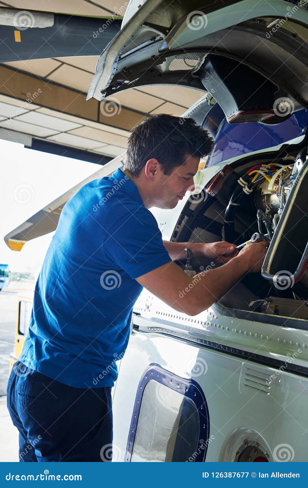 Male Aero Engineer Working on Helicopter in Hangar Stock Image - Image ...