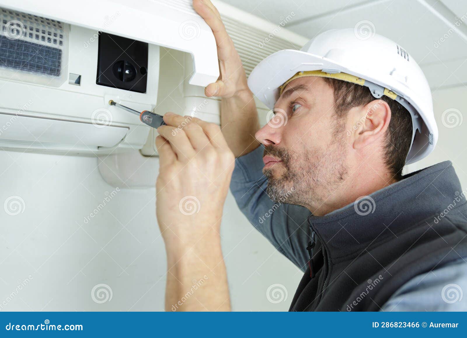 Male Air Conditioning Technician Using Driver Stock Photo - Image of ...