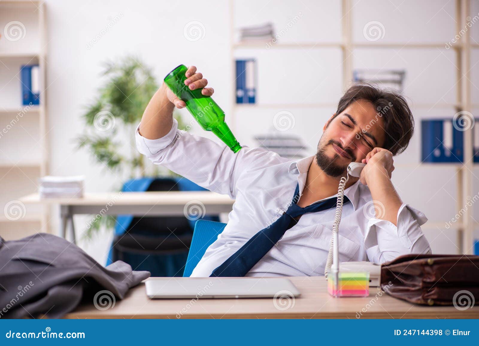 Young Alcohol Addicted Employee Sitting in the Office Stock Photo ...