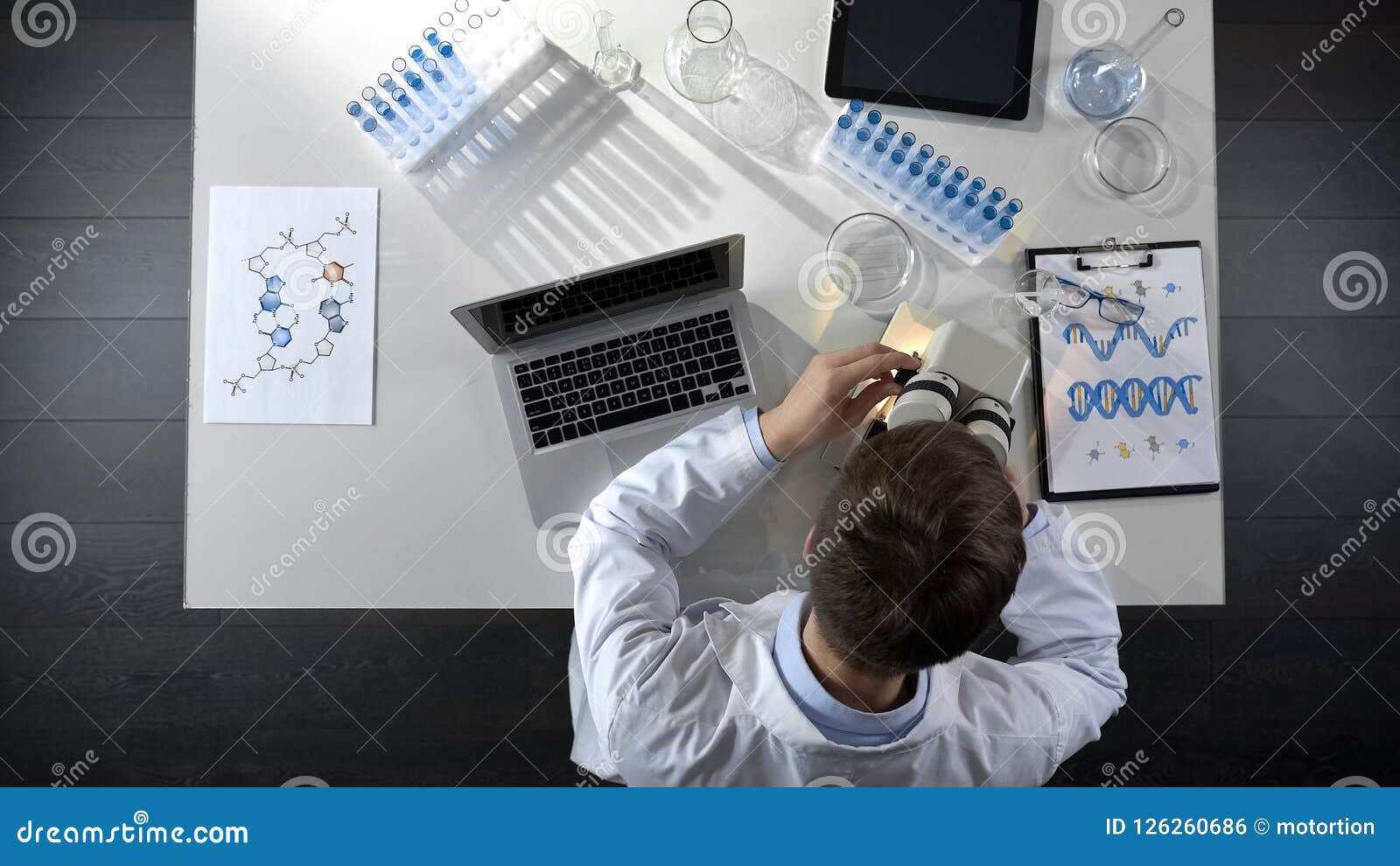 Male Analyst Doing Observations of Sample Under Microscope, Lab ...