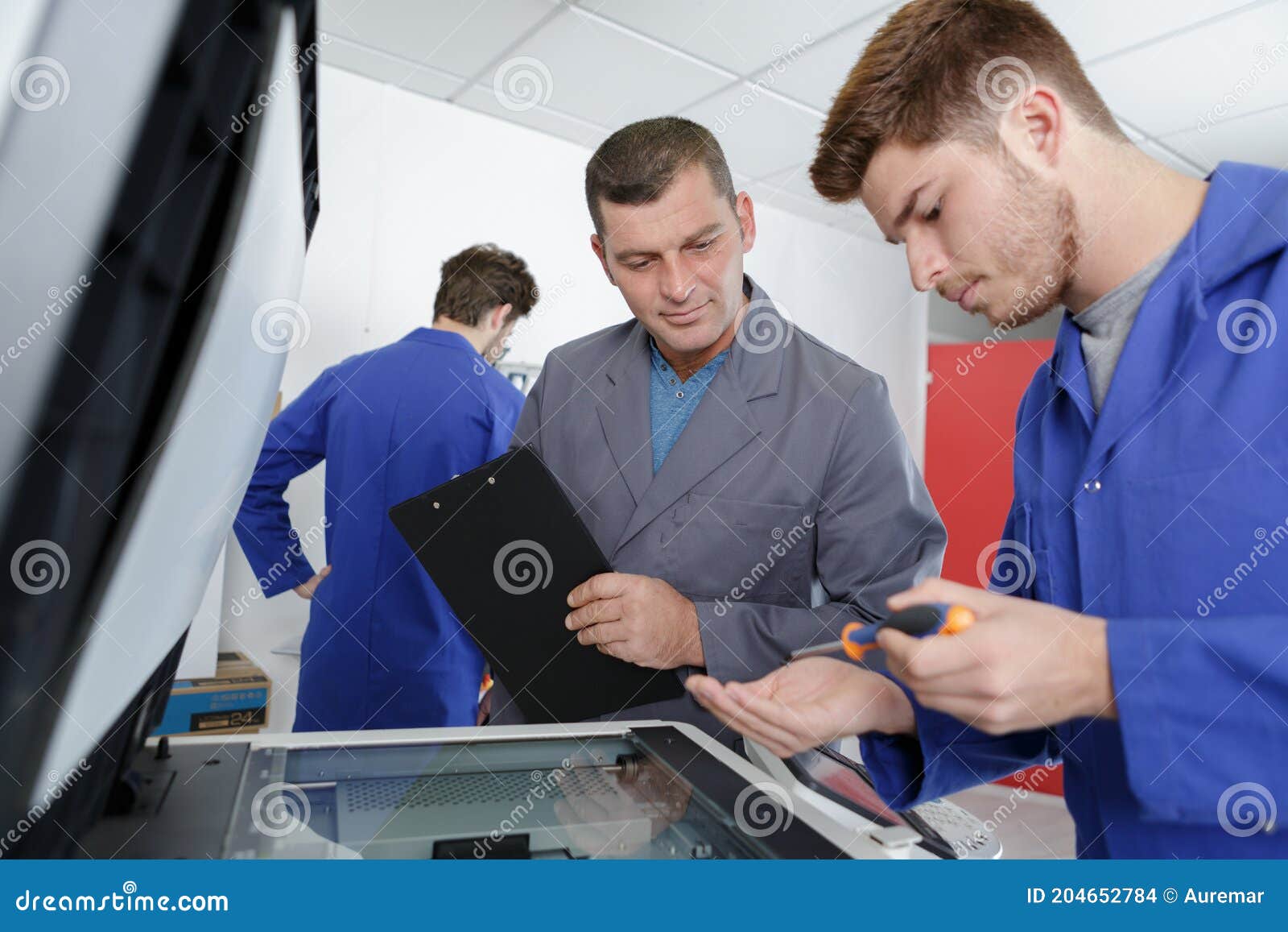 Male Apprentice Fixing Printer Supervisor Watching Stock Photo - Image ...