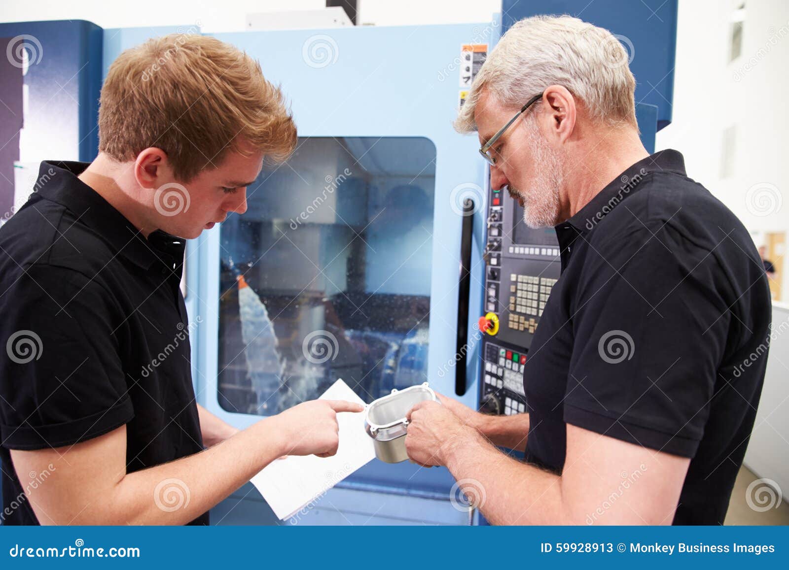Male Apprentice Working with Engineer on CNC Machinery Stock Image ...