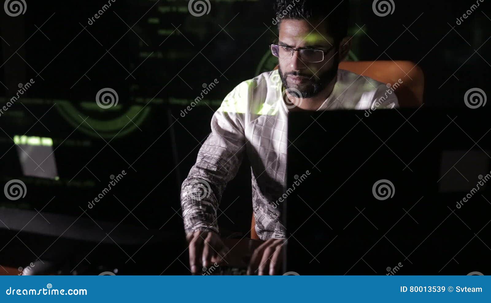 Male Arabic Hacker Hacks Computer in Dark. Computer Code Reflecting on ...