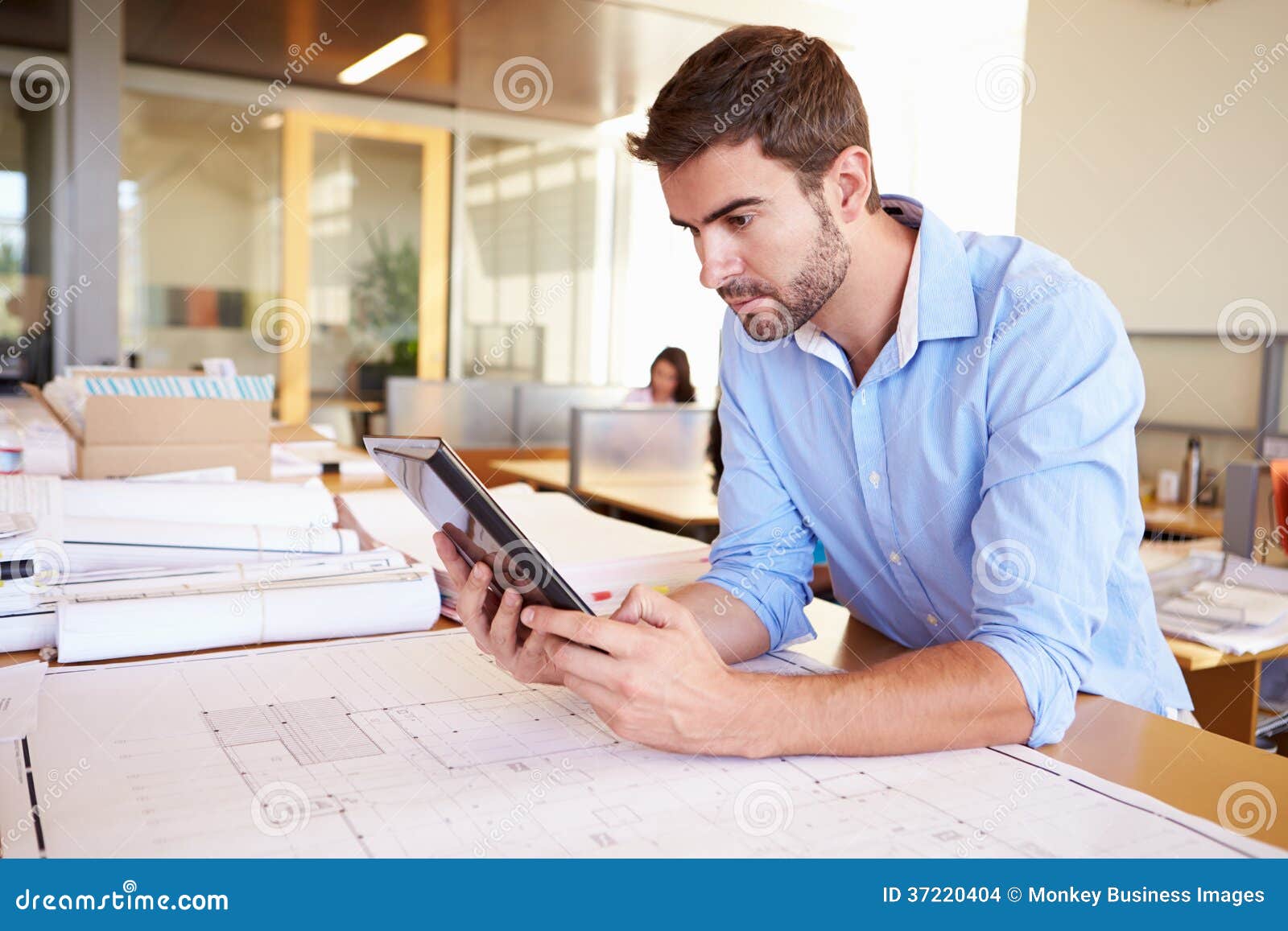 Male Architect Writing Notes On Clip Board Stock Photo | CartoonDealer ...