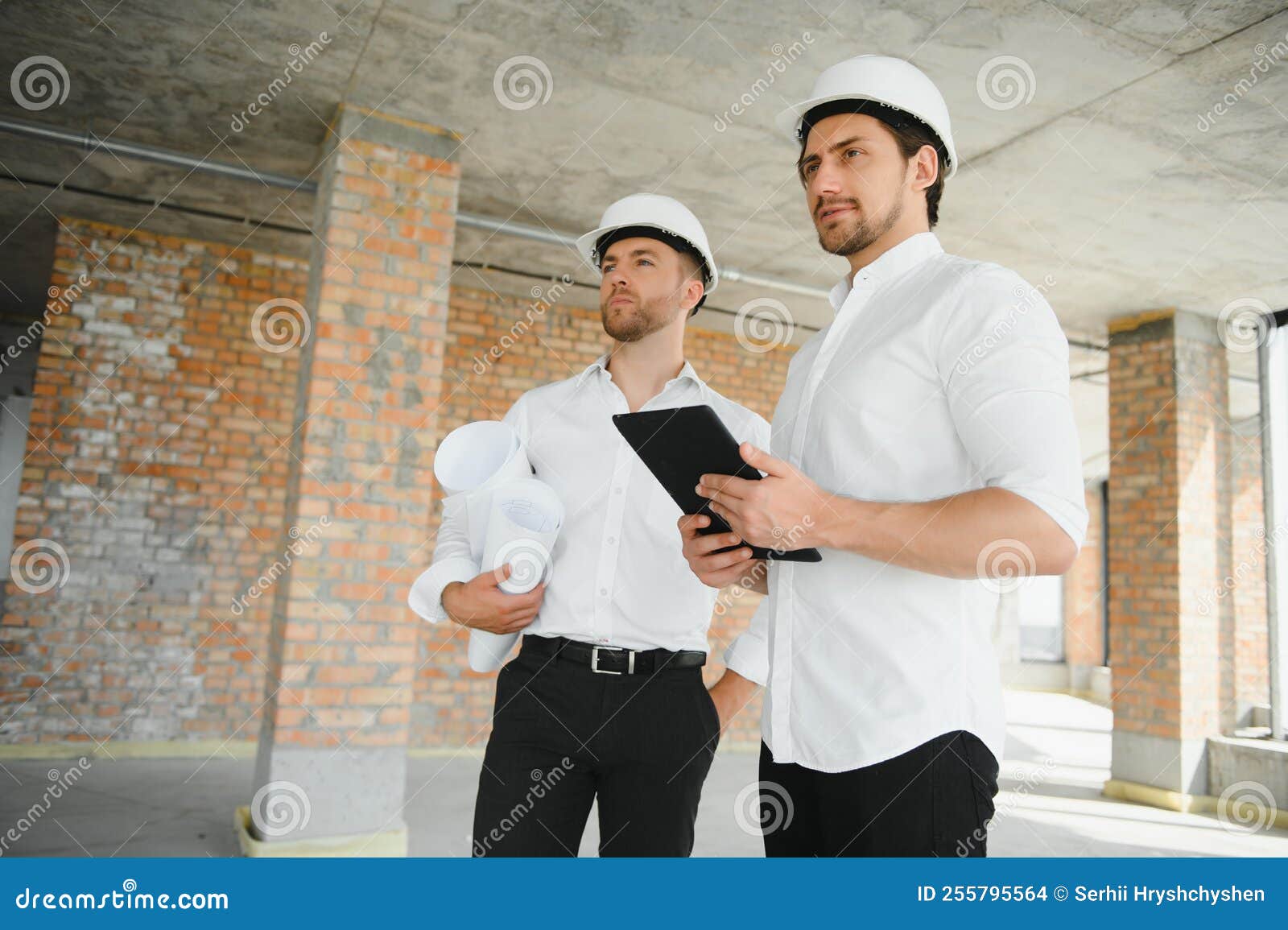 Male Architect Giving Instructions To His Foreman at Construction Site ...