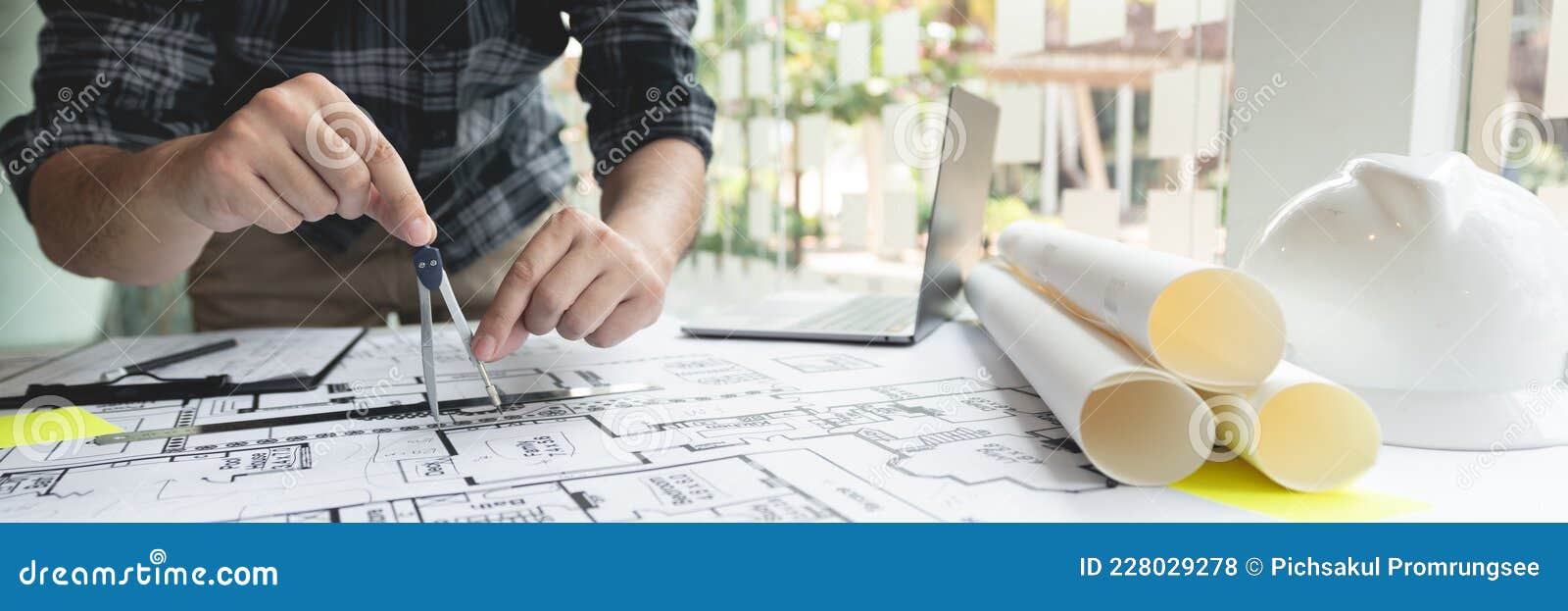 A Male Architect Using Compasses Measuring and Marking the Scale Ratio ...