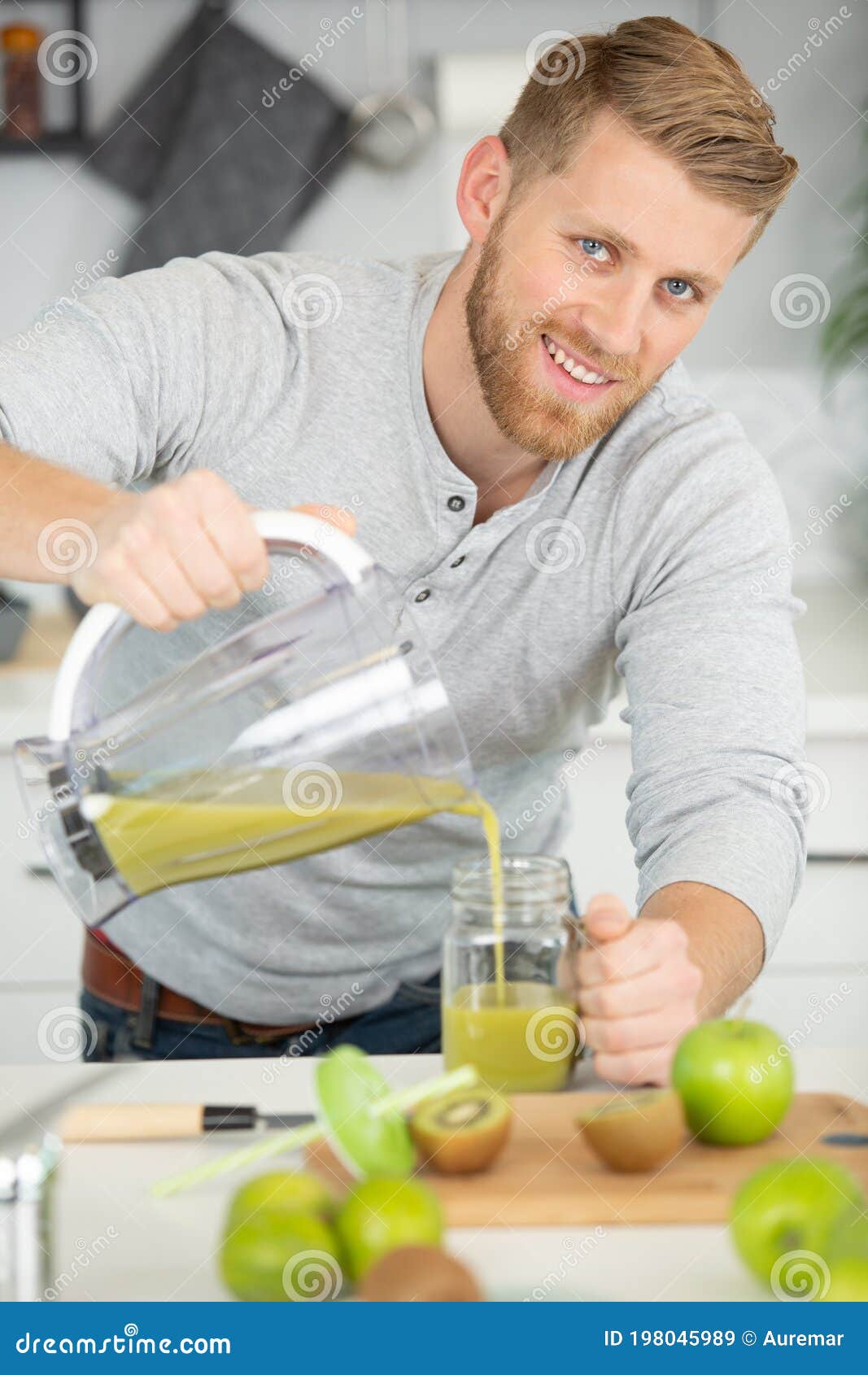 Male Athlete Making Juice or Smoothie in Kitchen Stock Image - Image of ...
