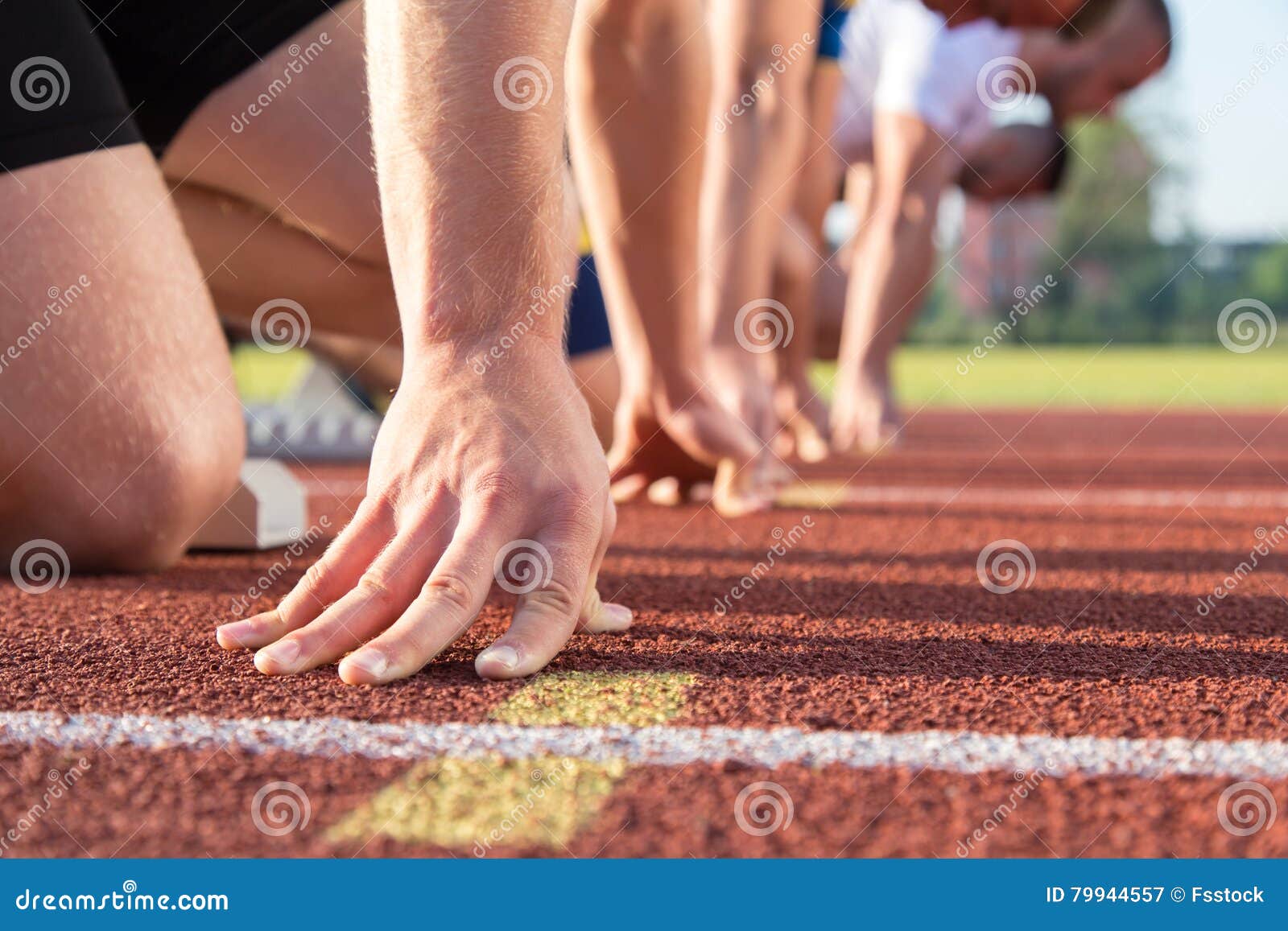 Male Athletes at Starting Line on Sunny Day. Stock Image - Image of ...