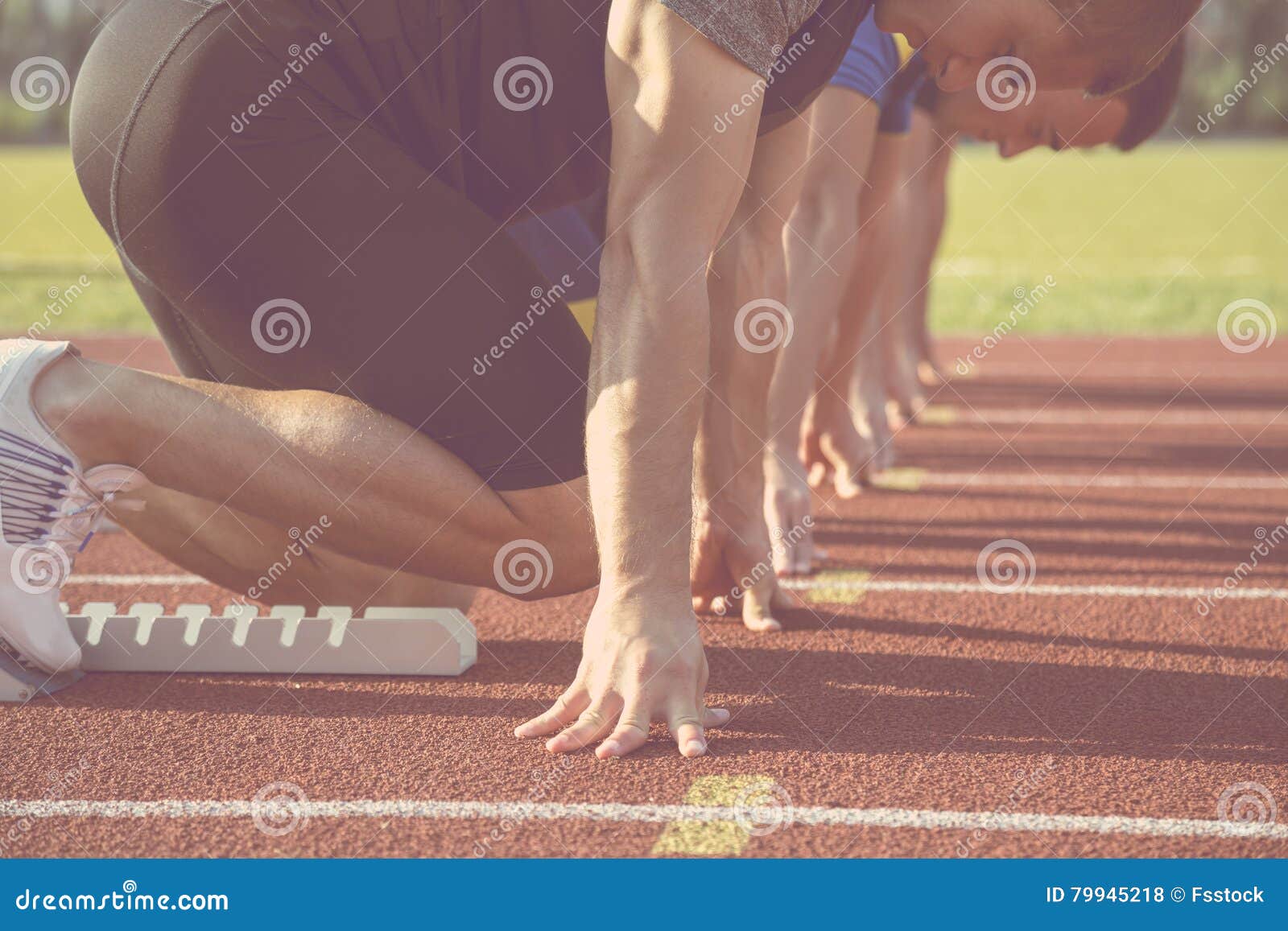 Male Athletes at Starting Line on Sunny Day. Stock Photo - Image of ...