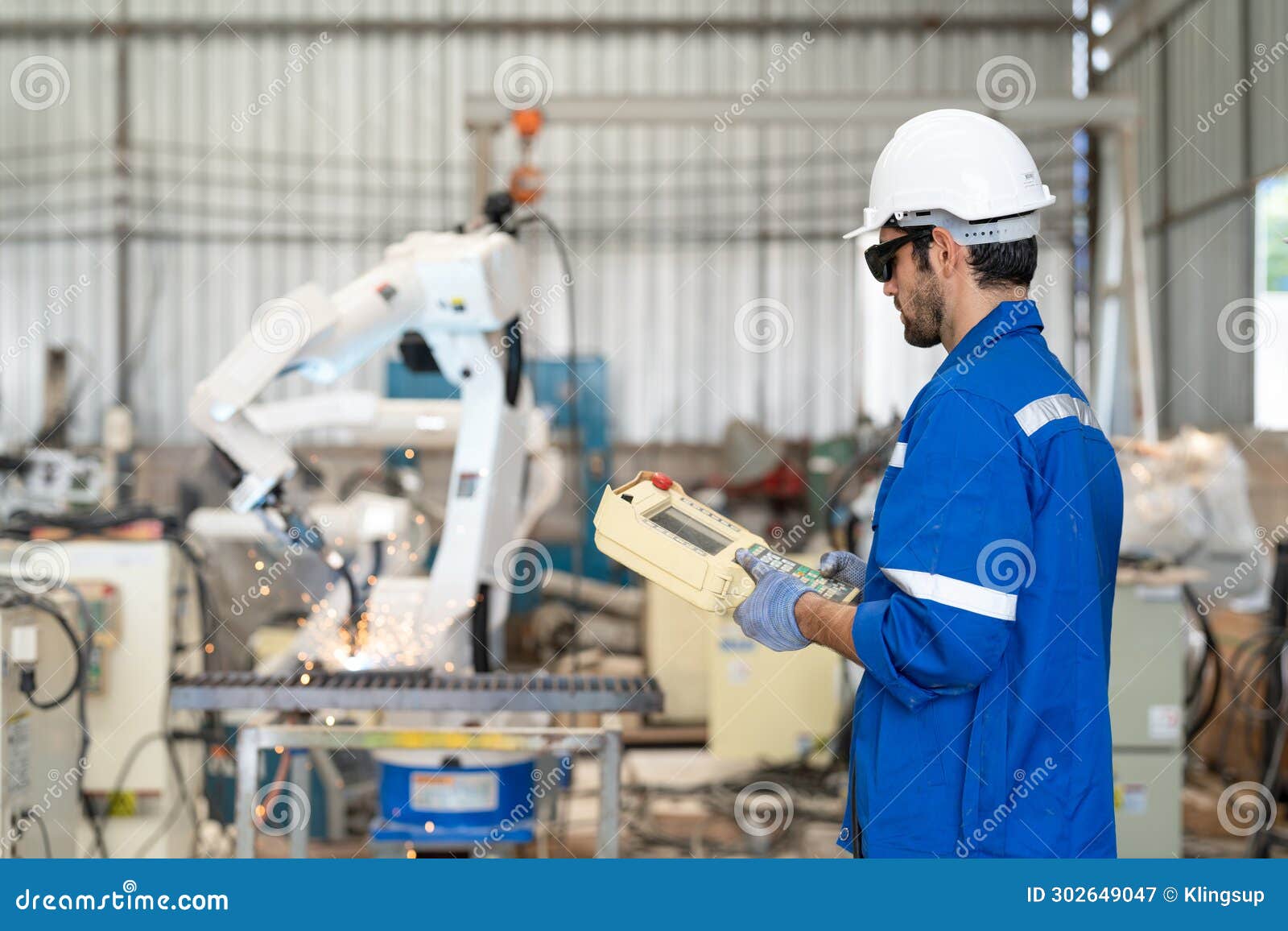 Male Automation Engineer Using Remote Controller Control Robot Arm ...