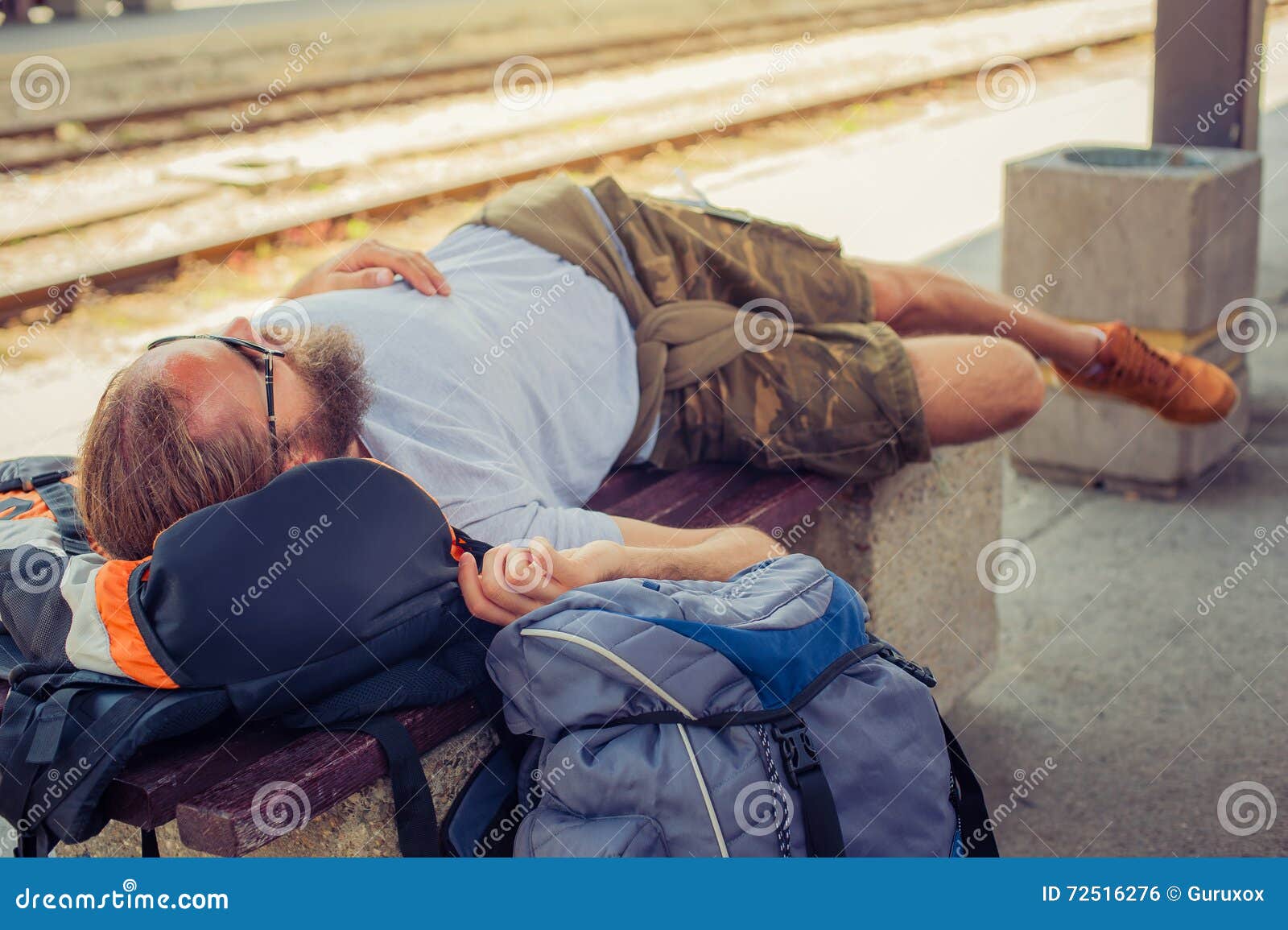 Male Backpacker Tourist Napping on a Bench Stock Photo - Image of ...