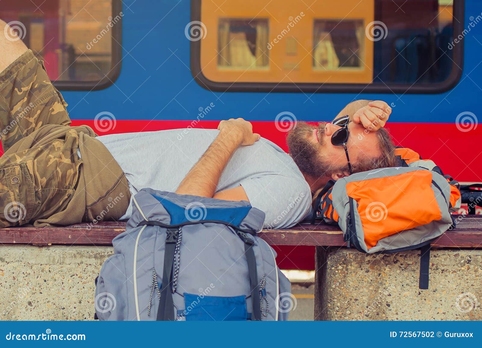 Male Backpacker Tourist Napping on a Bench Stock Photo - Image of ...
