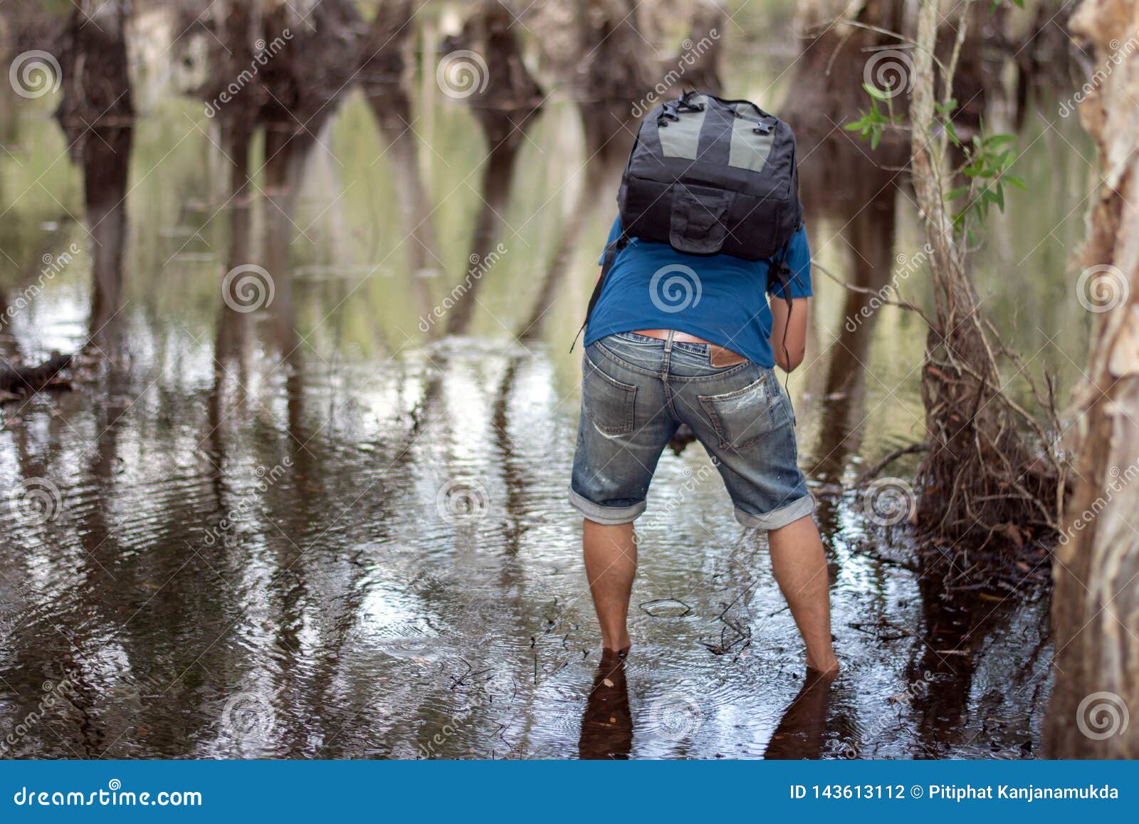 Male Backpacker through Tropical Jungle Stream Deep in the Rain Forest ...