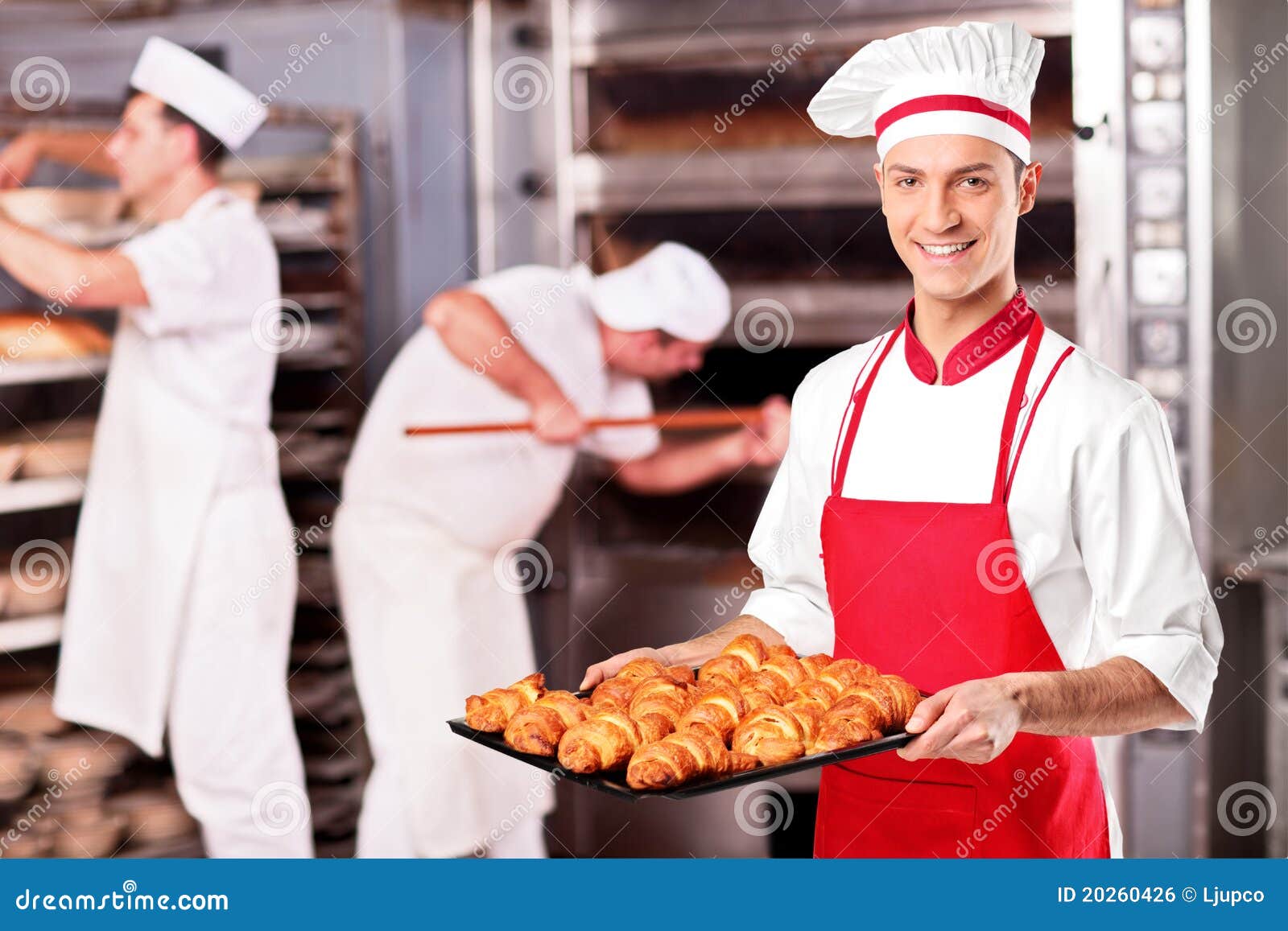 Male Baker Holding Croissants in Bakery Stock Photo - Image of ...